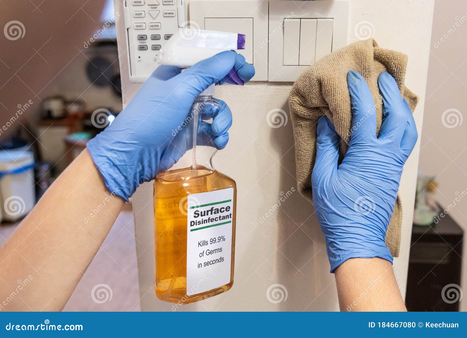 Person in Gloves Disinfecting Light Switch Panel Surface with ...
