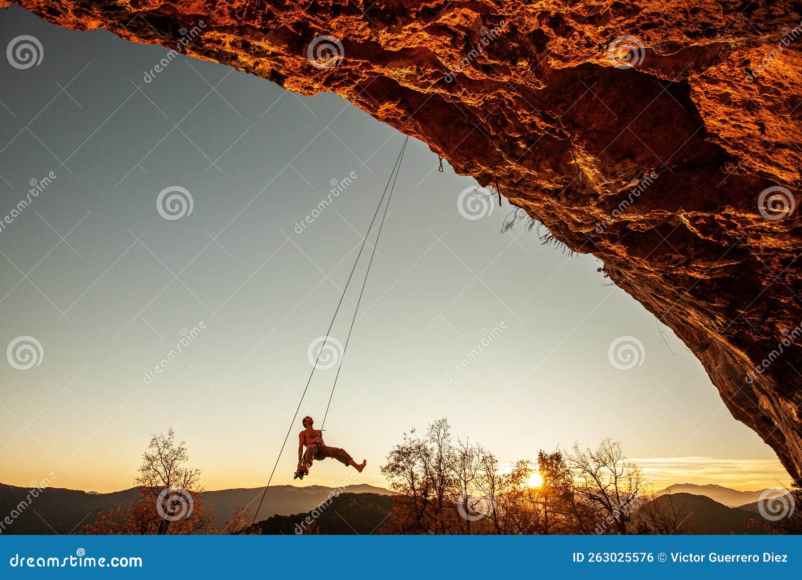 Men Hiding, Looking at the Rock at Sunset with the Mountains and the ...
