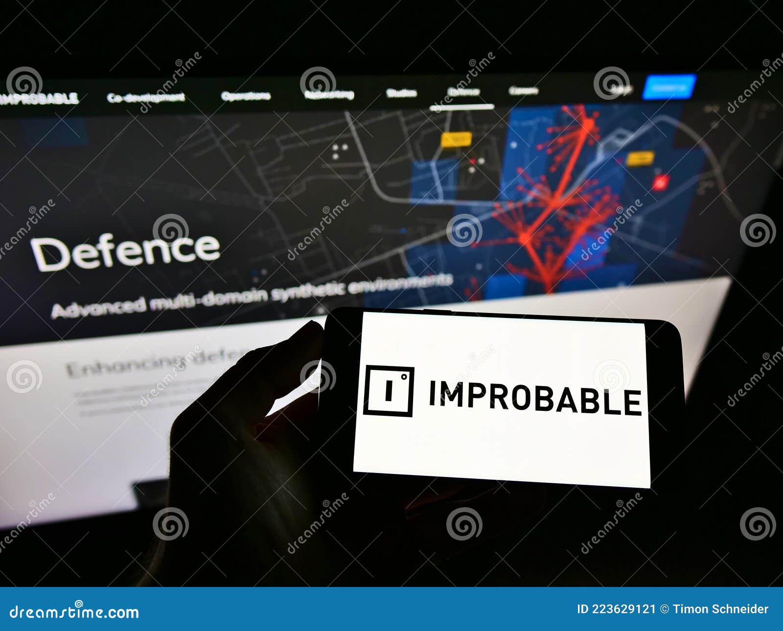 Person Holding Cellphone with Logo of British Software Developer ...