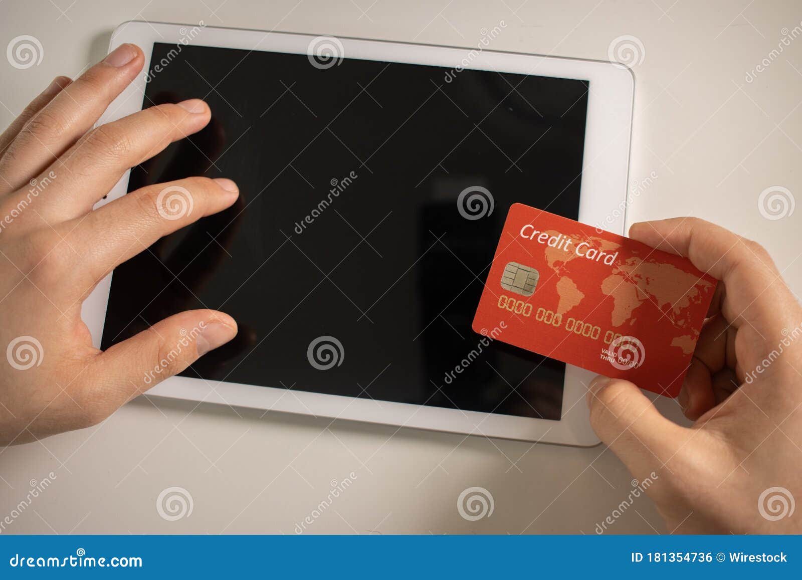 Person Holding a Credit Card with a Tablet on a White Table Stock Photo ...