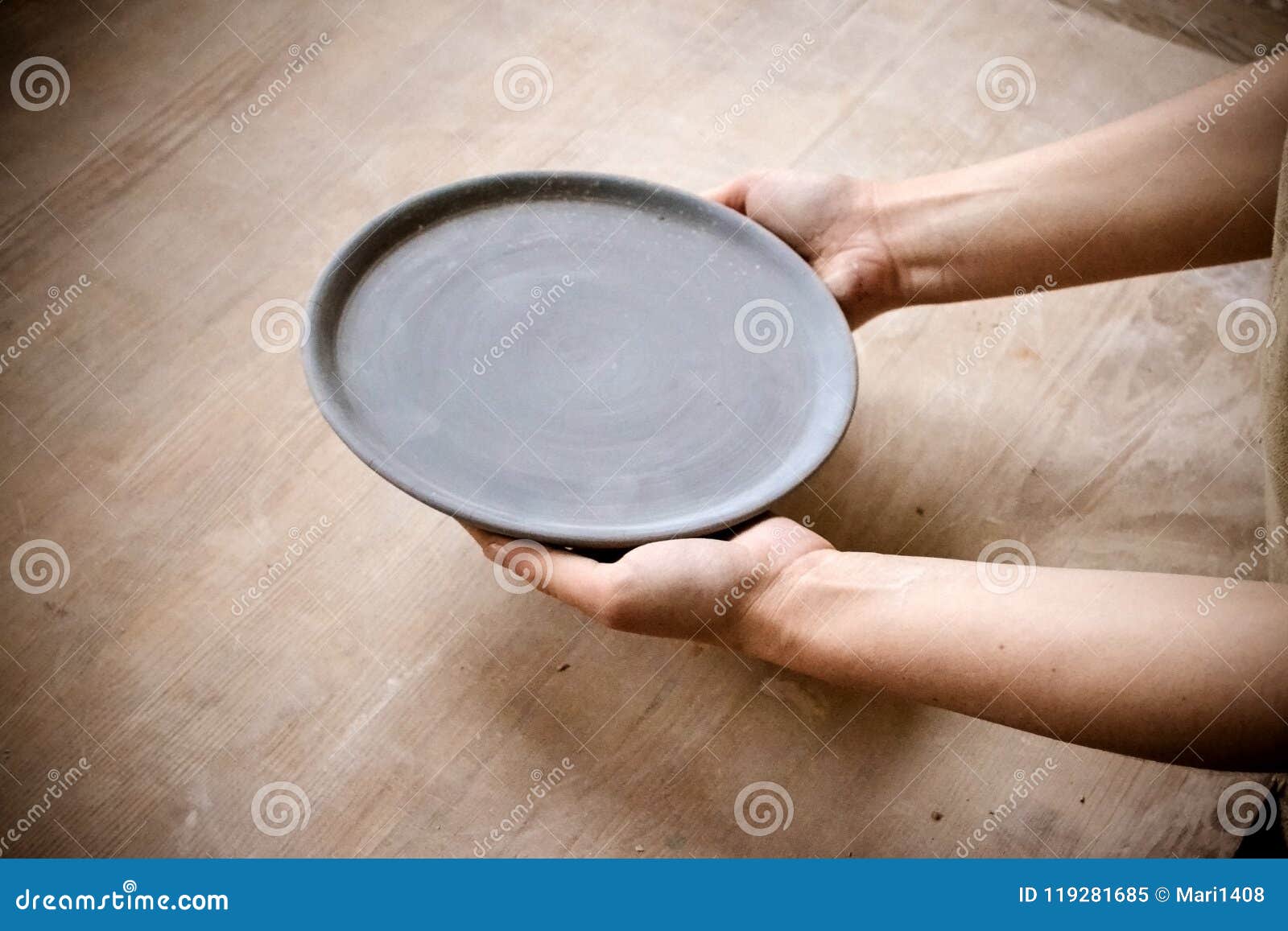 Person Holding an Empty Plate on a Wooden Table Stock Image - Image of ...
