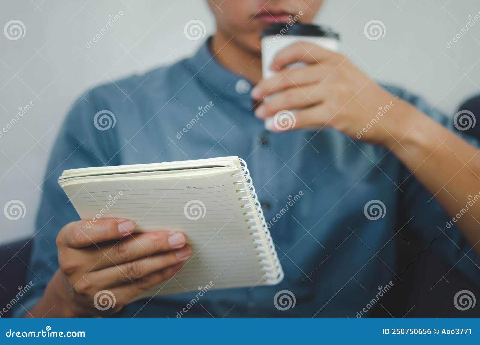 Person Holding a Note Book and a Paper Coffee Cup Stock Photo - Image ...