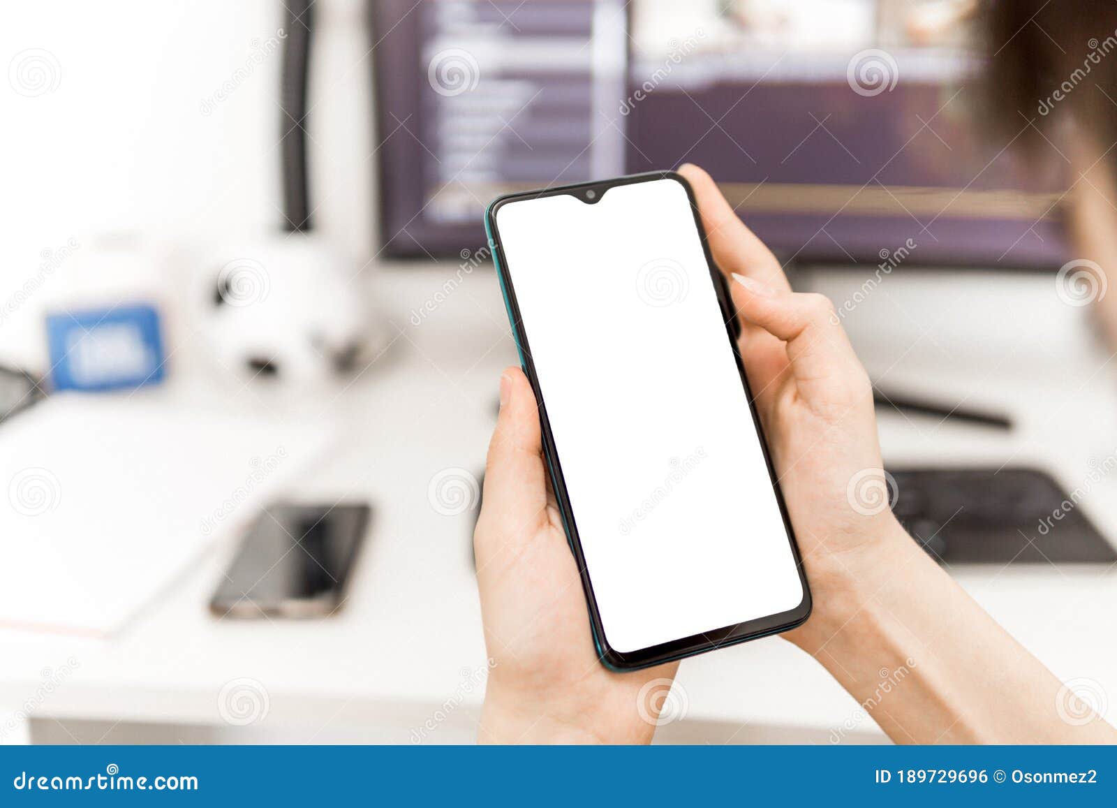 Person Holding Phone with Blank Screen in Hands at Work Desk Stock ...