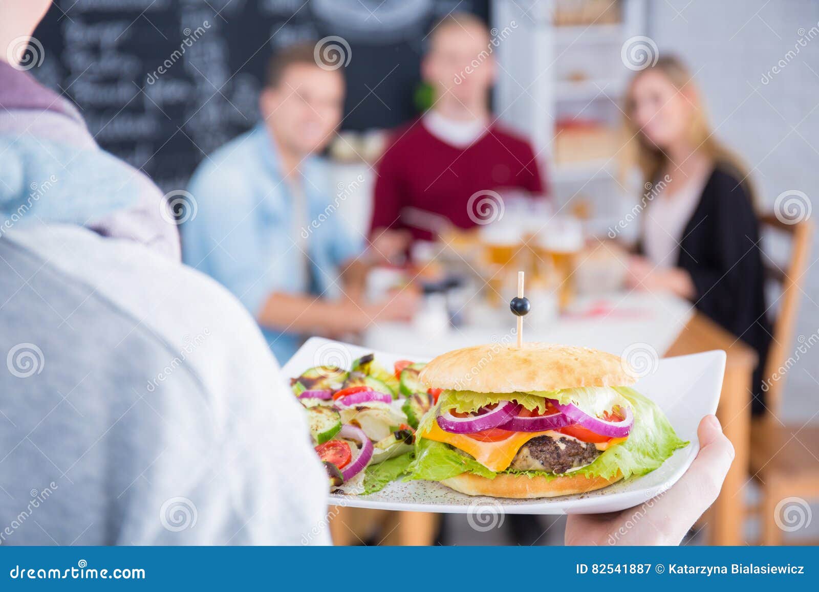 Person Holding Plate with Cheeseburger Stock Image - Image of ...