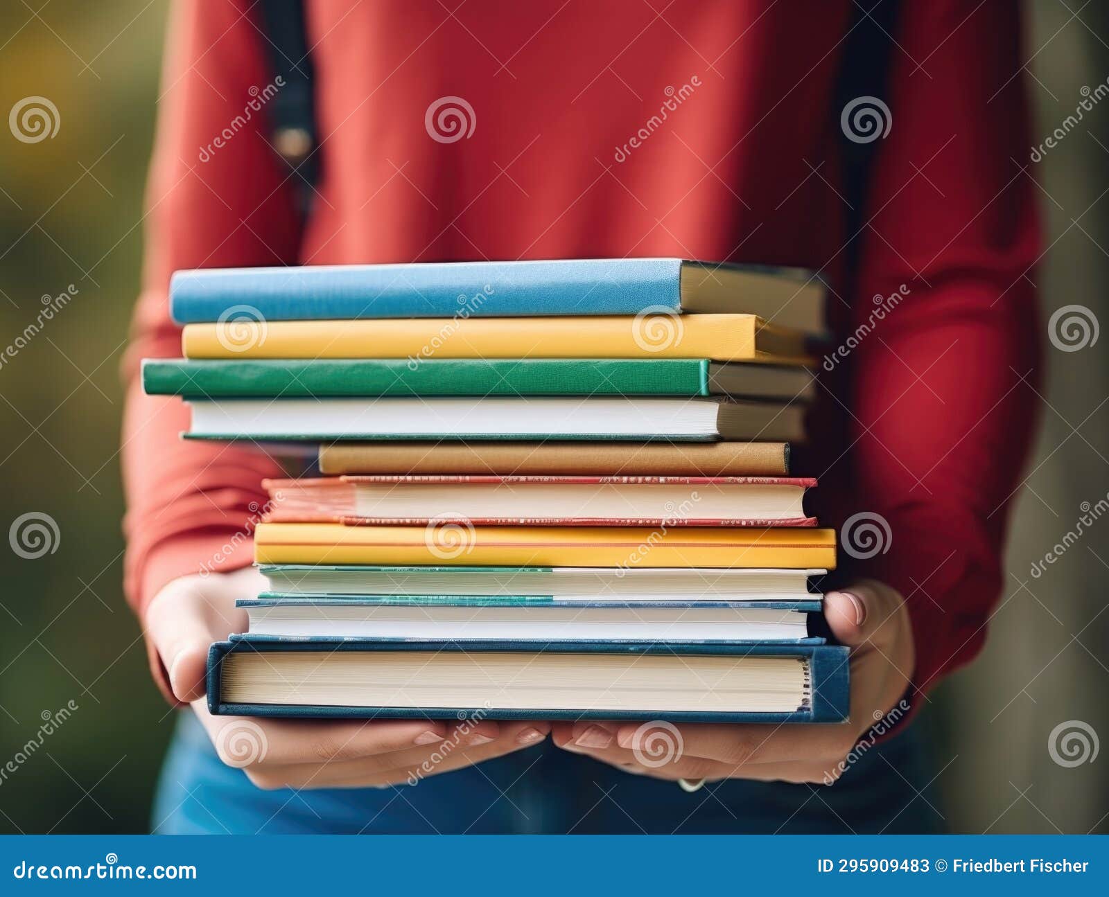 A Person Holding a Stack of Books in Their Hands, Education Day Concept ...