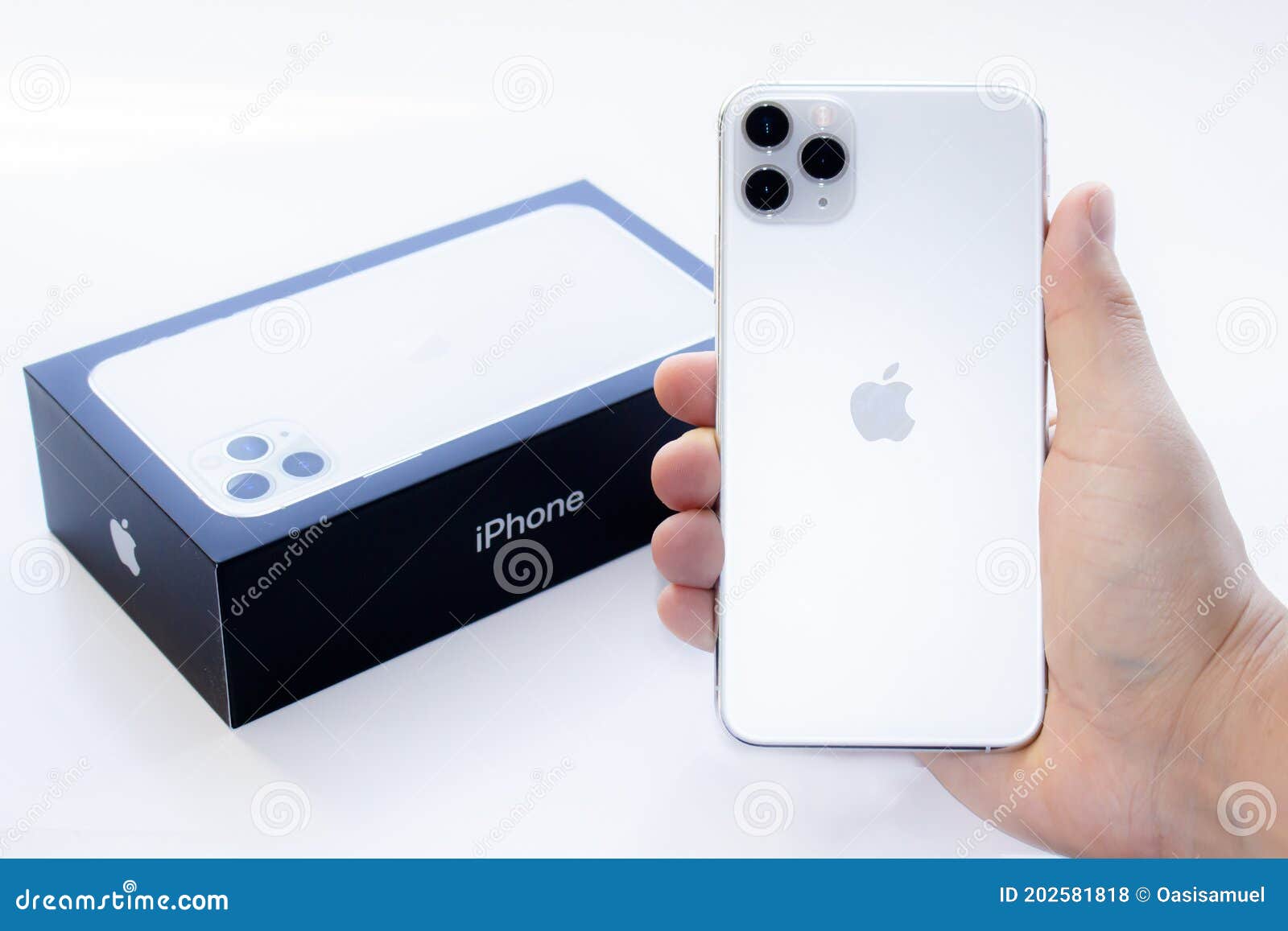 A Person Holding a White IPhone 11 Pro Max with the Box on the ...