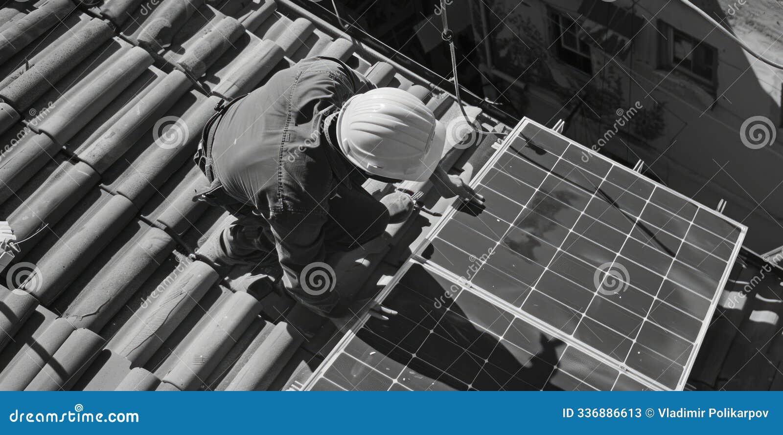 A Person Installing a Solar Panel on the Rooftop, for Renewable Energy ...
