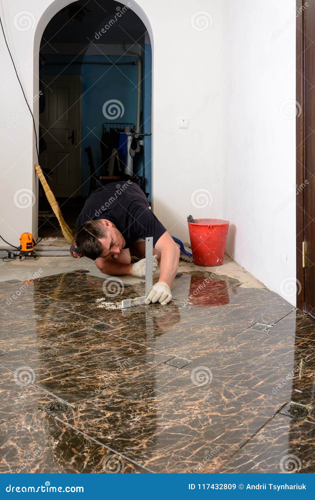 A Person with a Laser Level Checks the Installed Floor Tile Stock Image ... A Person with a Laser Level Checks the Installed Floor Tile Stock Image ...