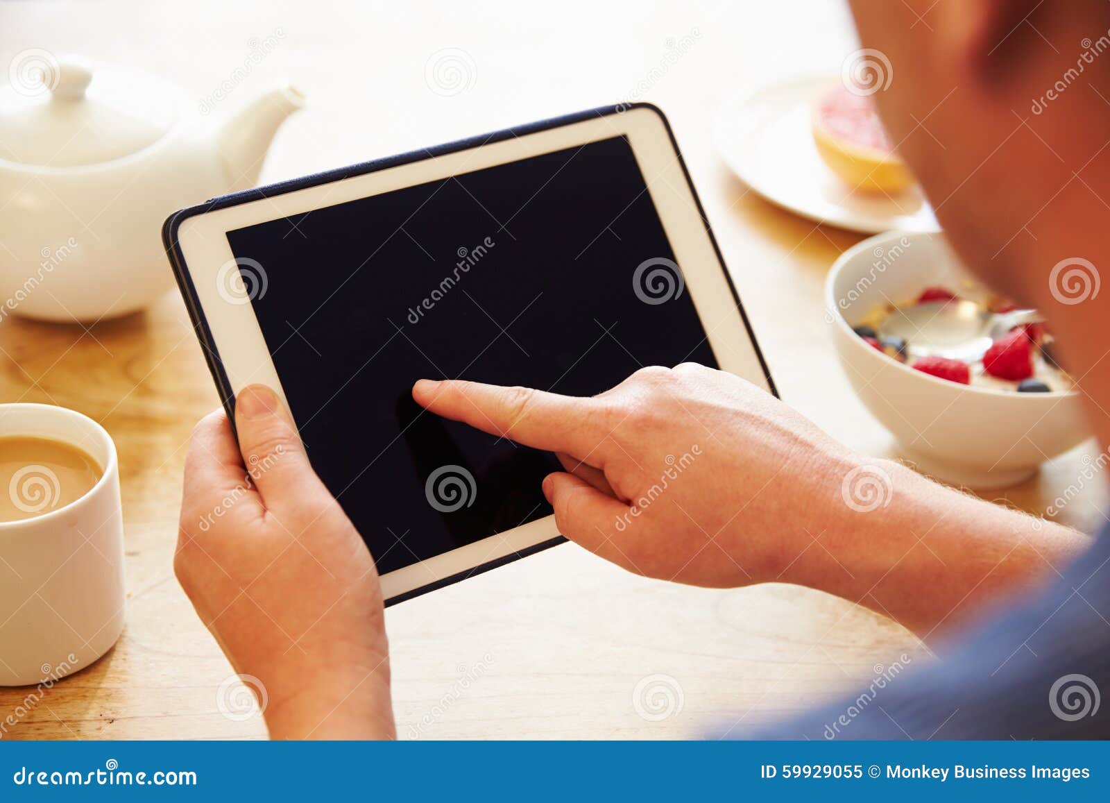 Person Looking at Digital Tablet Whilst Eating Breakfast Stock Image ...