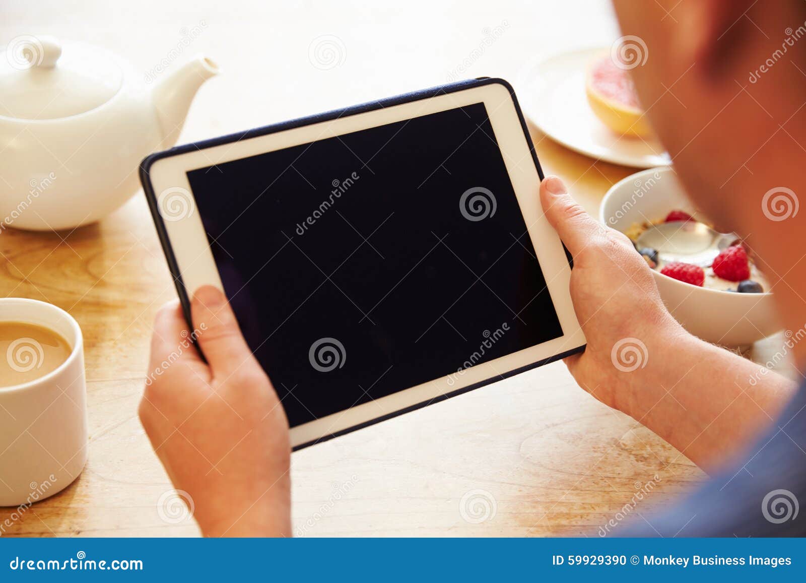 Person Looking at Digital Tablet Whilst Eating Breakfast Stock Photo ...