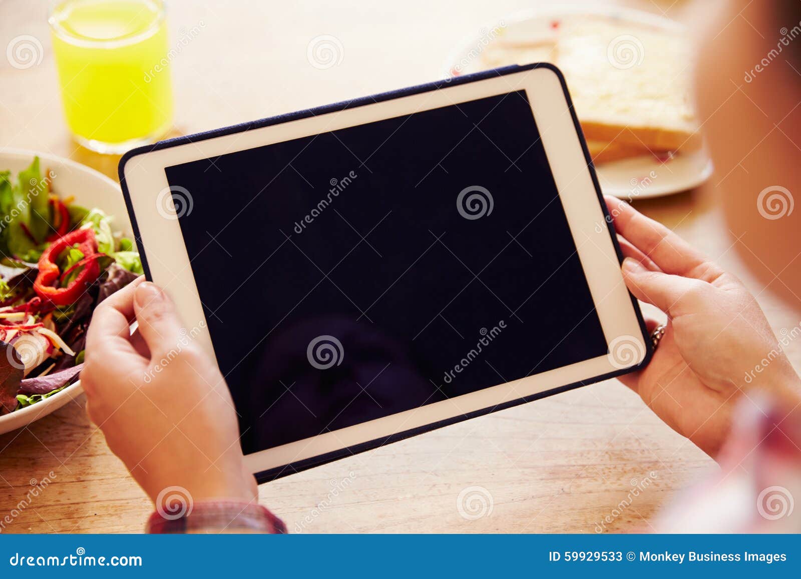 Person Looking at Digital Tablet Whilst Eating Lunch Stock Image ...