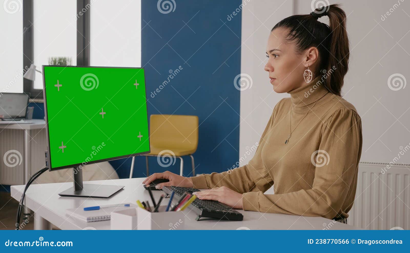 Person Looking at Green Screen on Computer Display in Office Stock ...