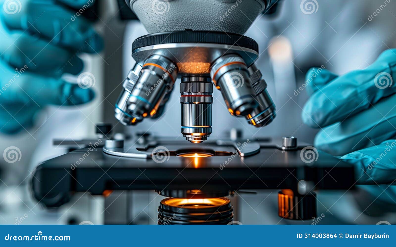 A Person is Looking through a Microscope in a Laboratory Stock ...