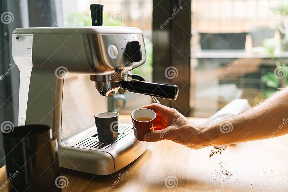 A Person Making Coffee with an Espresso Machine in a Cozy Kitchen ...