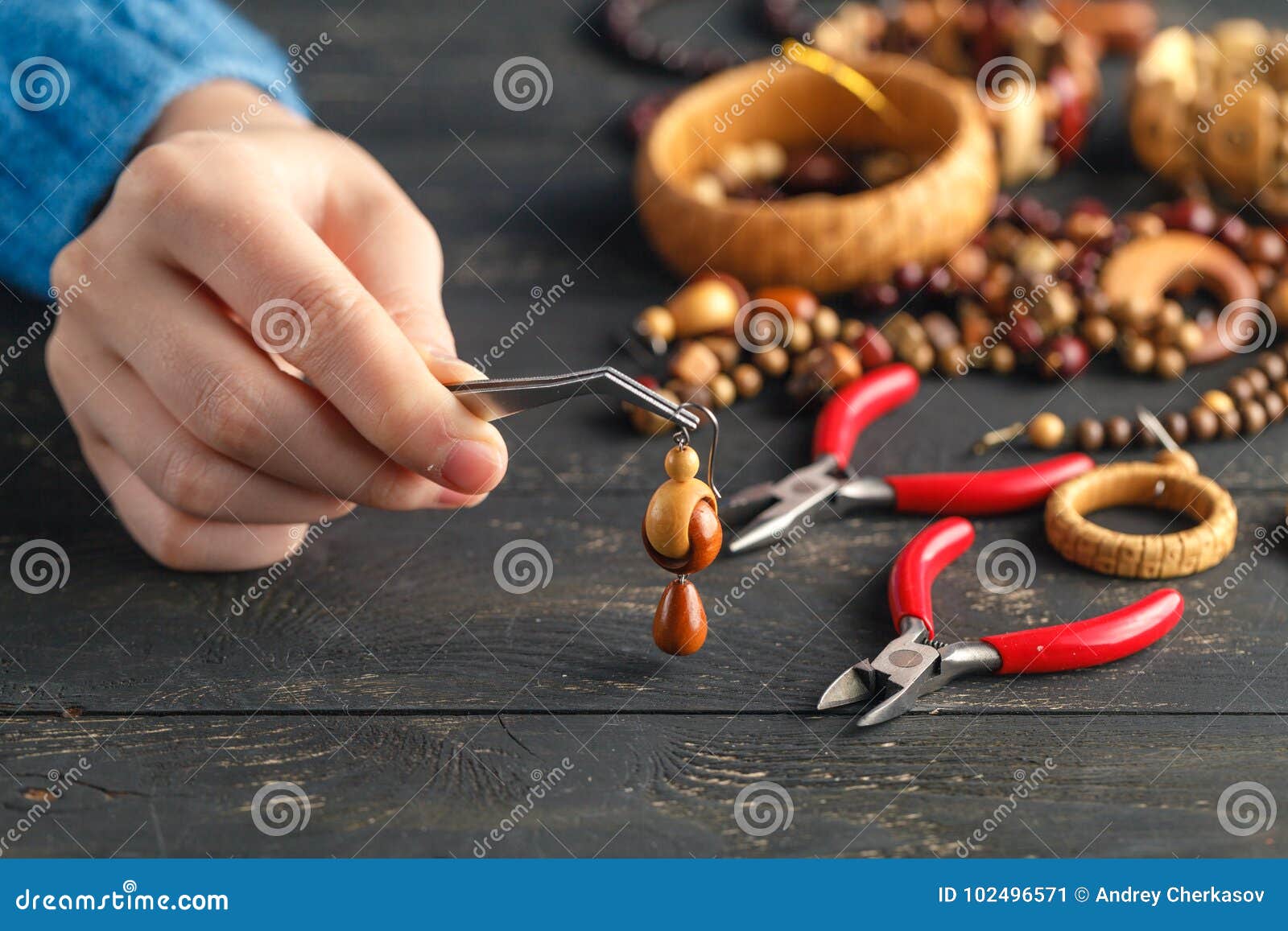 Person Making Jewelry Using Wire, Chains and Beads and Other Materials ...