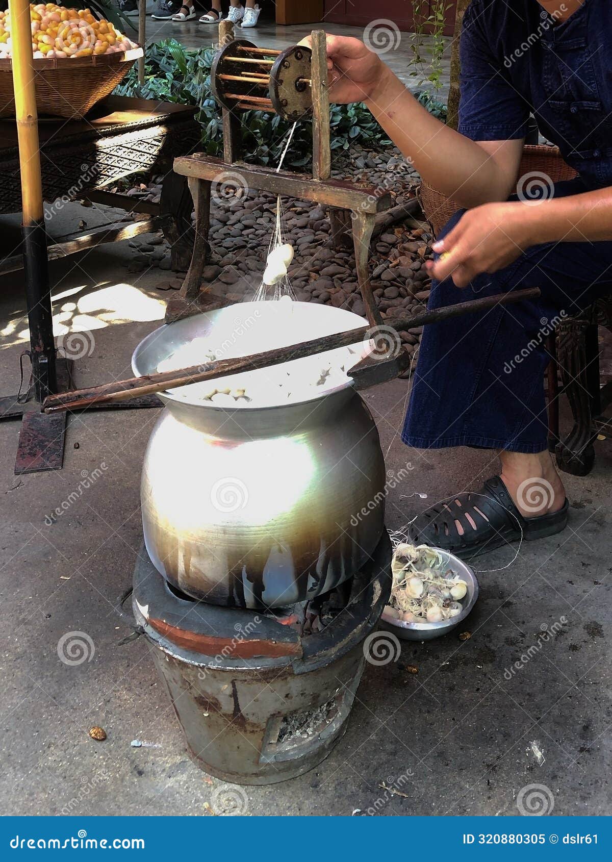 Traditional Silk Reeling Process with Spinning Wheel and Boiling Water ...