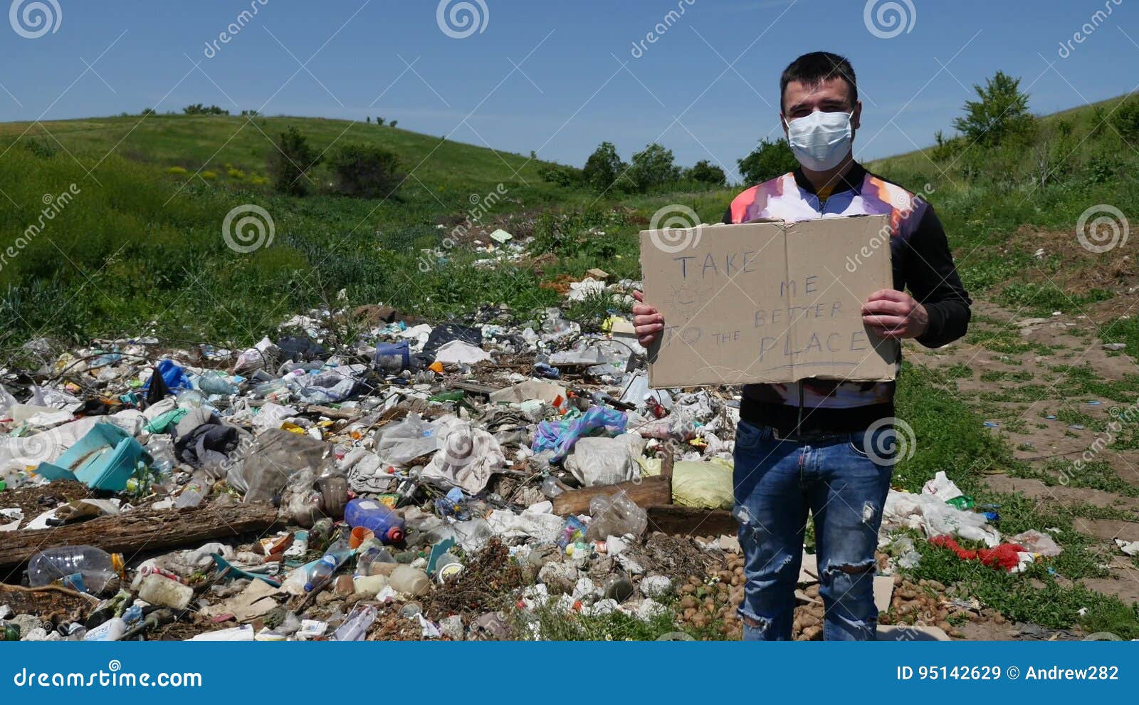 The Person in the Mask on the Garbage Holds a Sign with the Text ...
