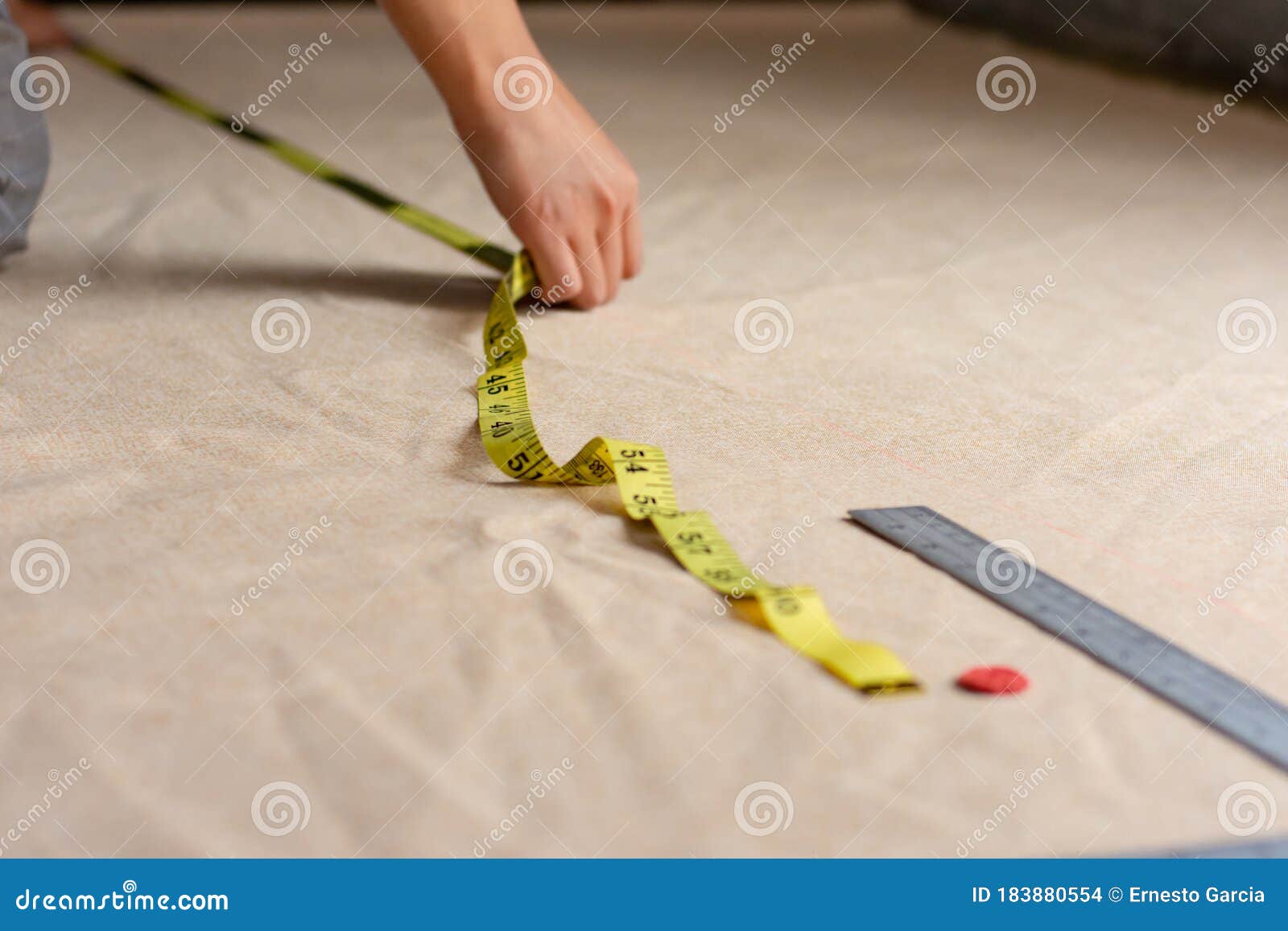 A Person is Measuring Fabric Using a Measuring Tape and Rules Stock ...