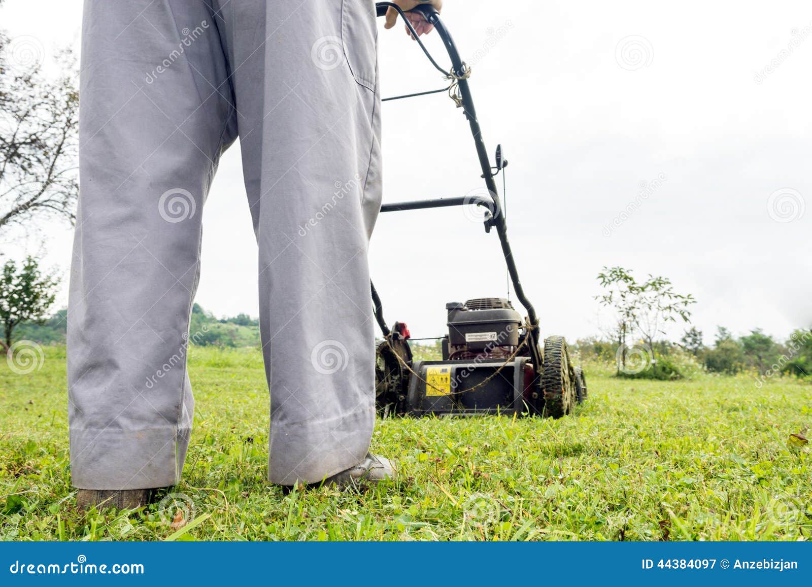 Person mowing a lawn stock image. Image of pushing, level - 44384097