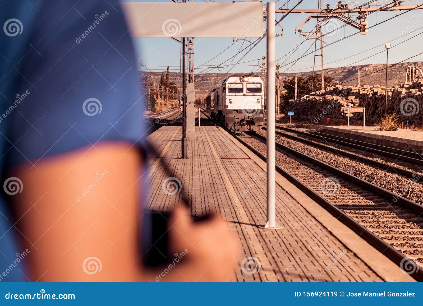 Person Near the Train Tracks while the Train is Approaching Stock Image ...