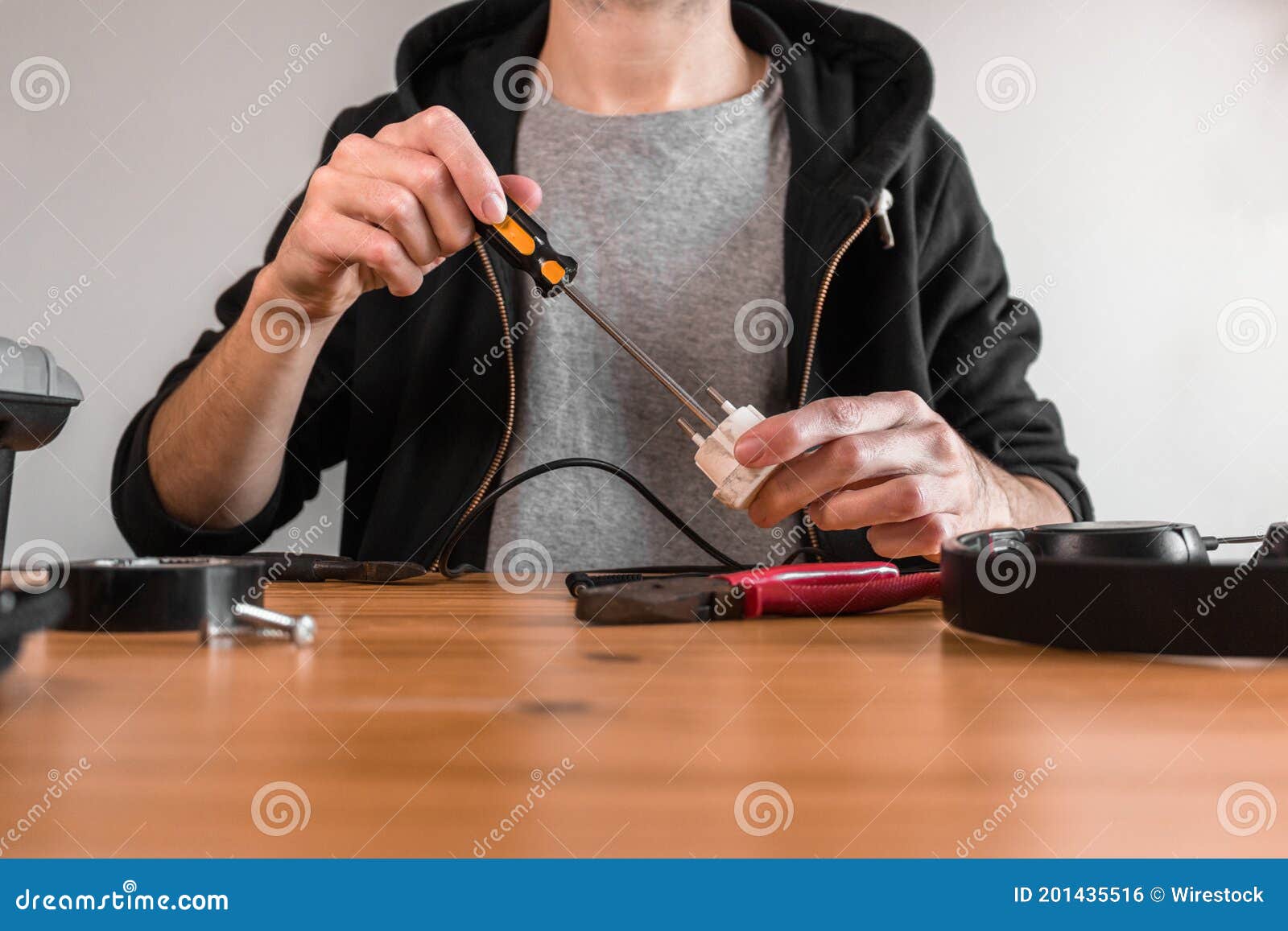 Person Opening an Electrical Adapter with a Screwdriver Stock Photo ...