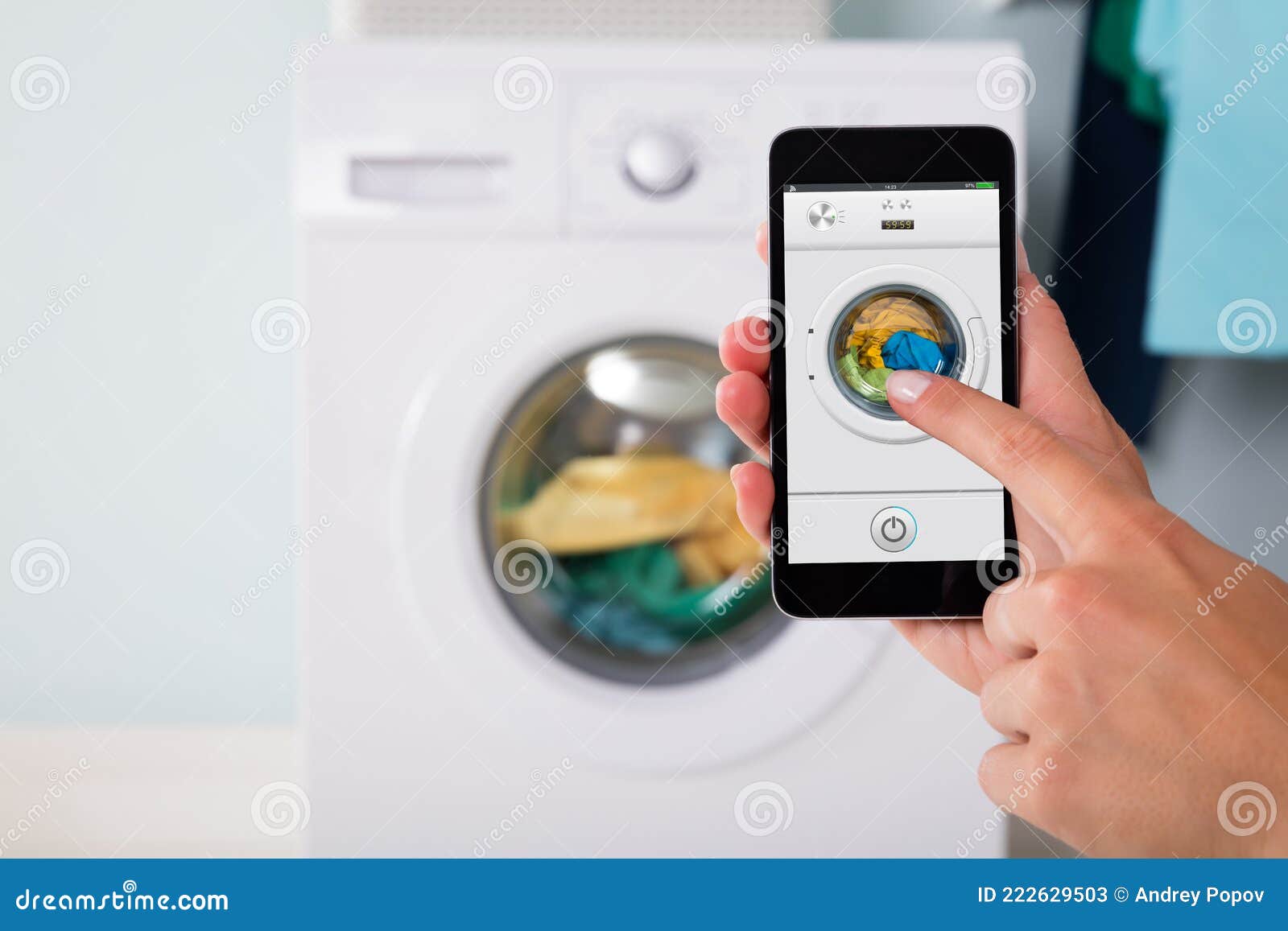 Person Operating Washing Machine Using Cellphone Stock Image - Image of ...