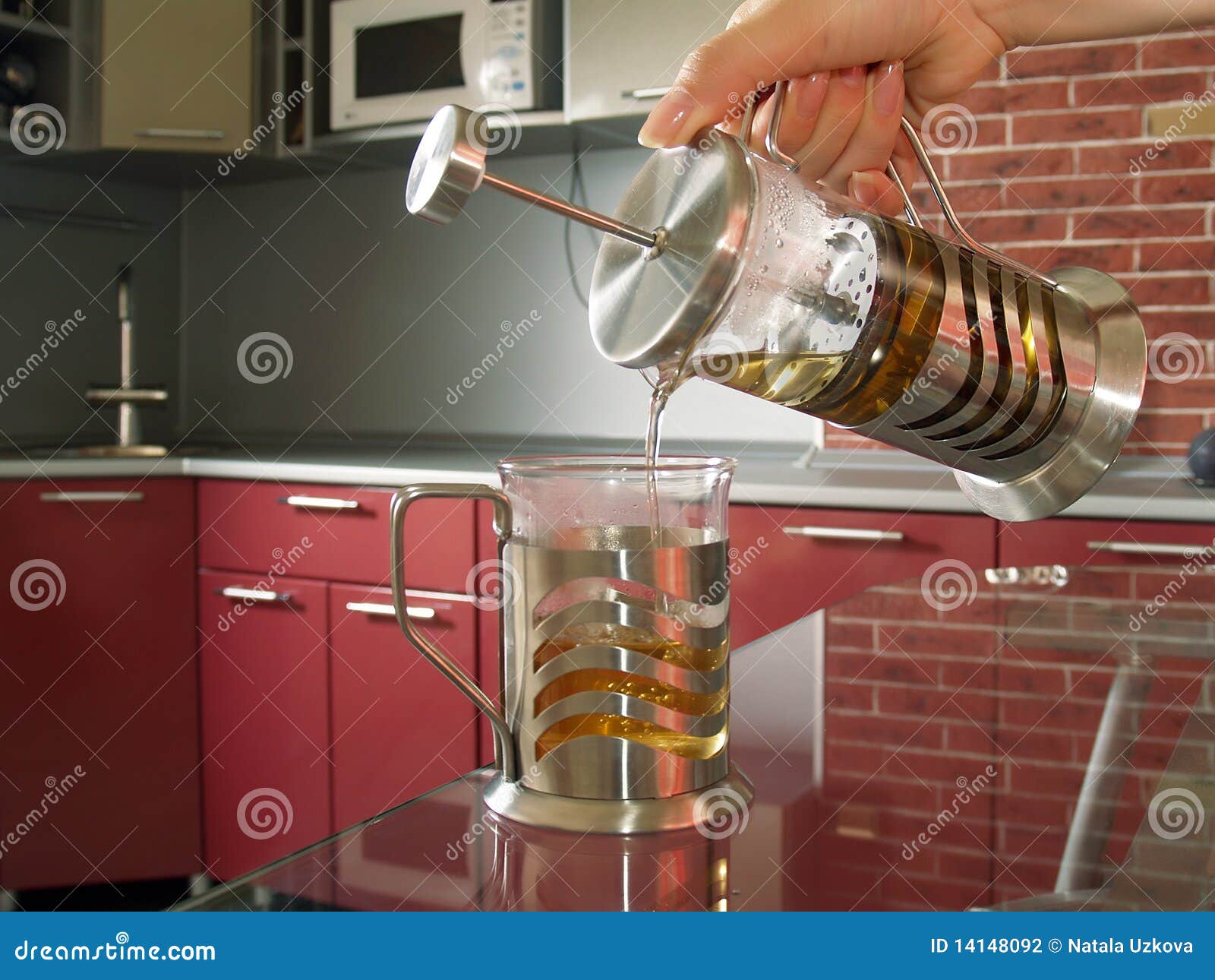 The Person Pours Tea from a Modern Teapot Stock Photo - Image of ...