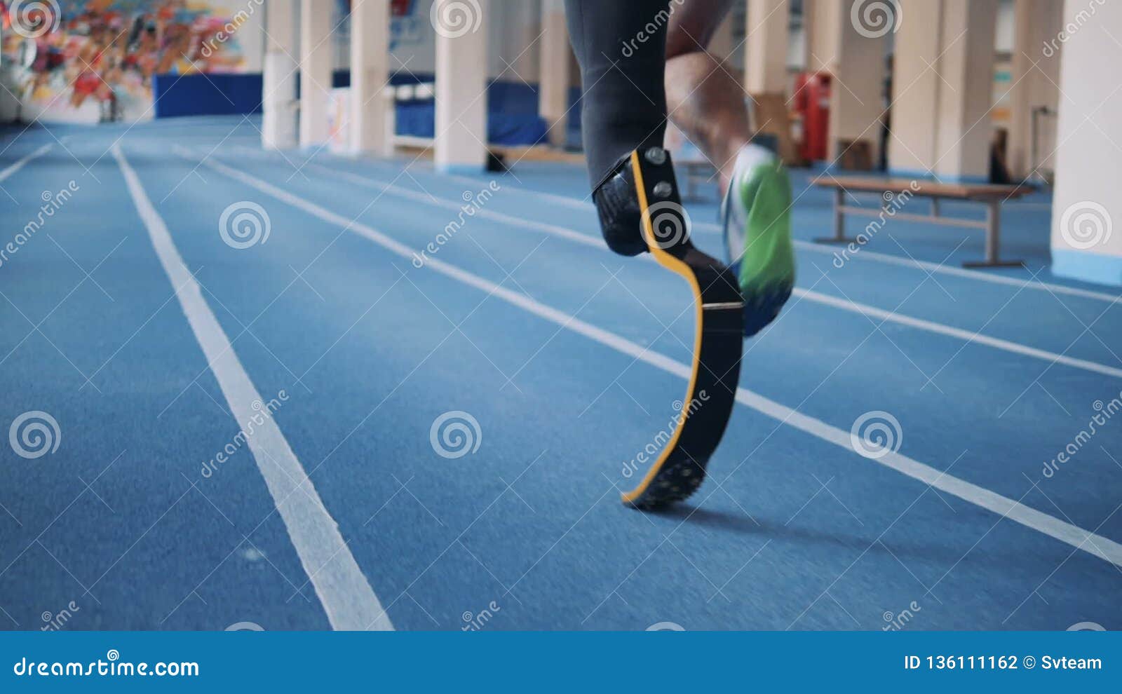 One Man with Bionic Leg Training on a Running Track, Back View. Stock ...