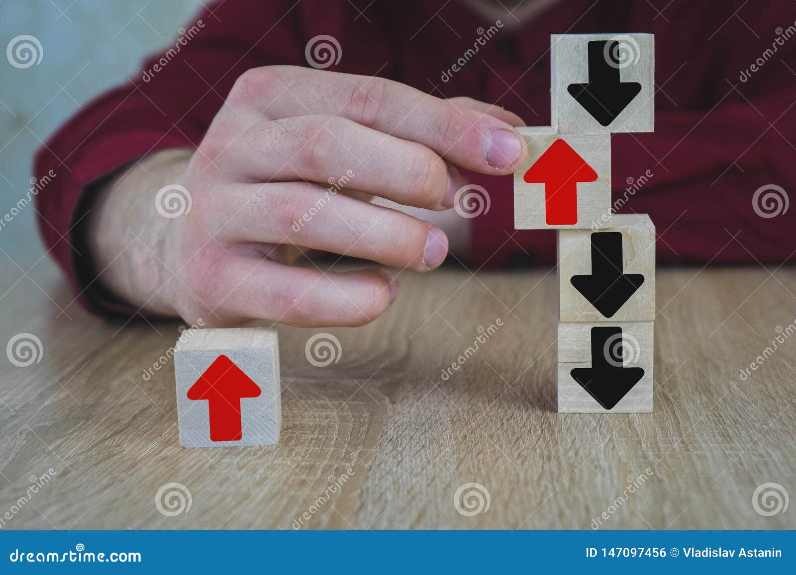 A Person Pulls One of the Wooden Cubes Standing on the Table, All of ...