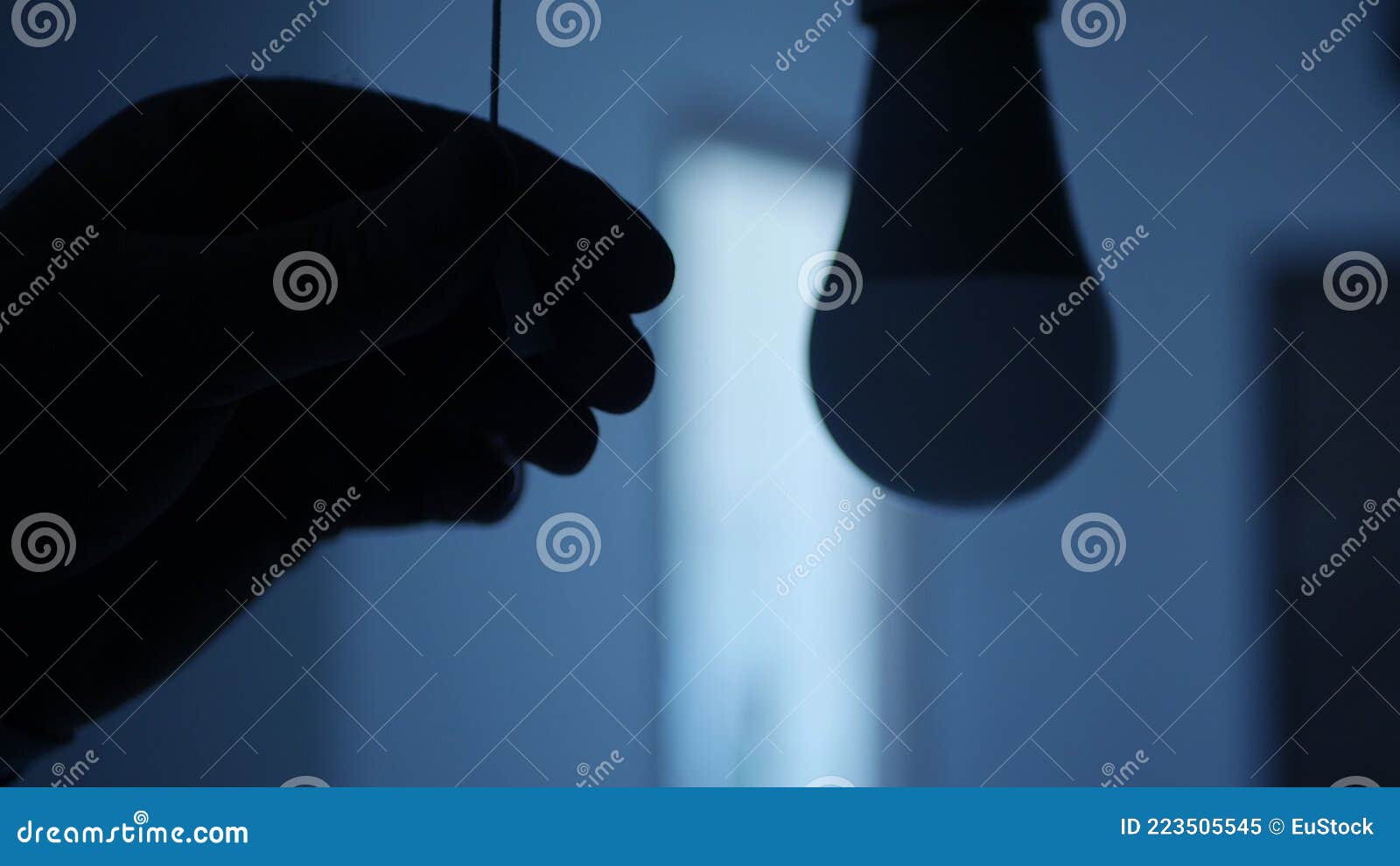 A Person Pulls the Switch Cord with His Hand and Turns Off the Light ...