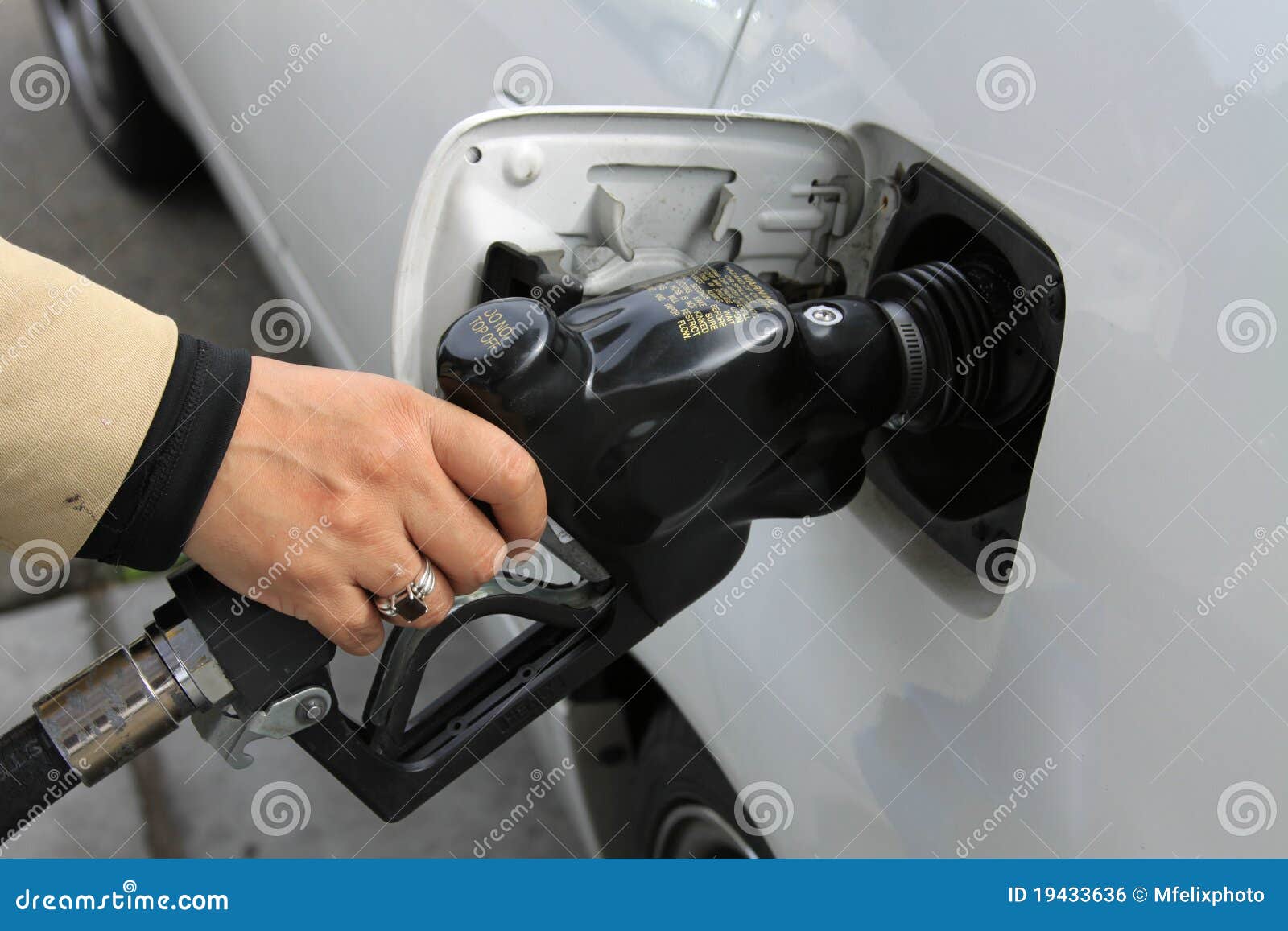 Person Pumping Gas stock photo. Image of auto, ring, jewelry - 19433636