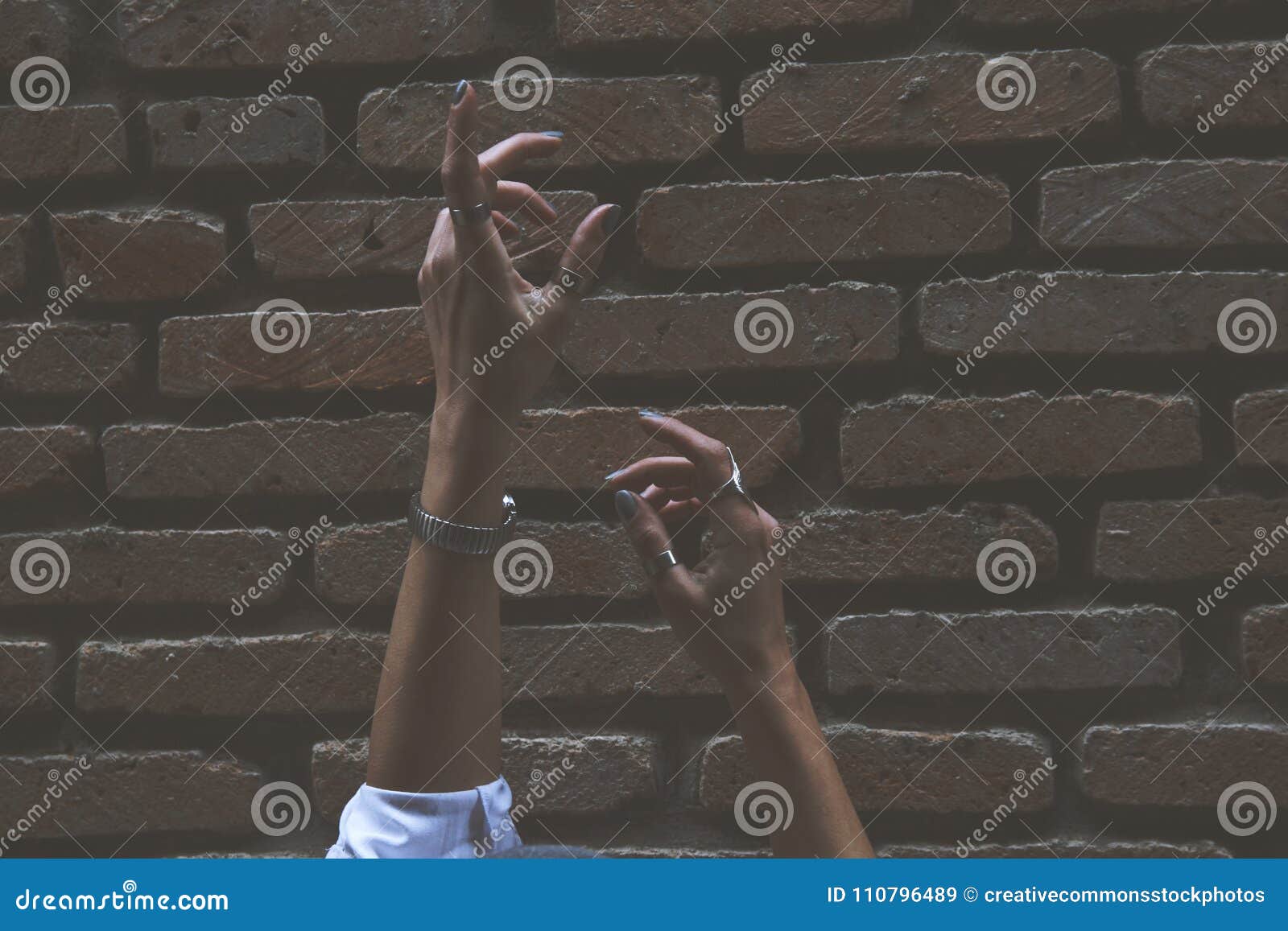 Person Raising Its Two Hand Beside Brown Brick Wall Picture. Image ...