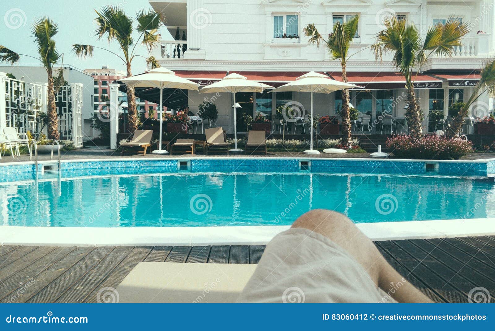 Person Relaxing Near a Swimming Pool Stock Photo - Image of hotel ...