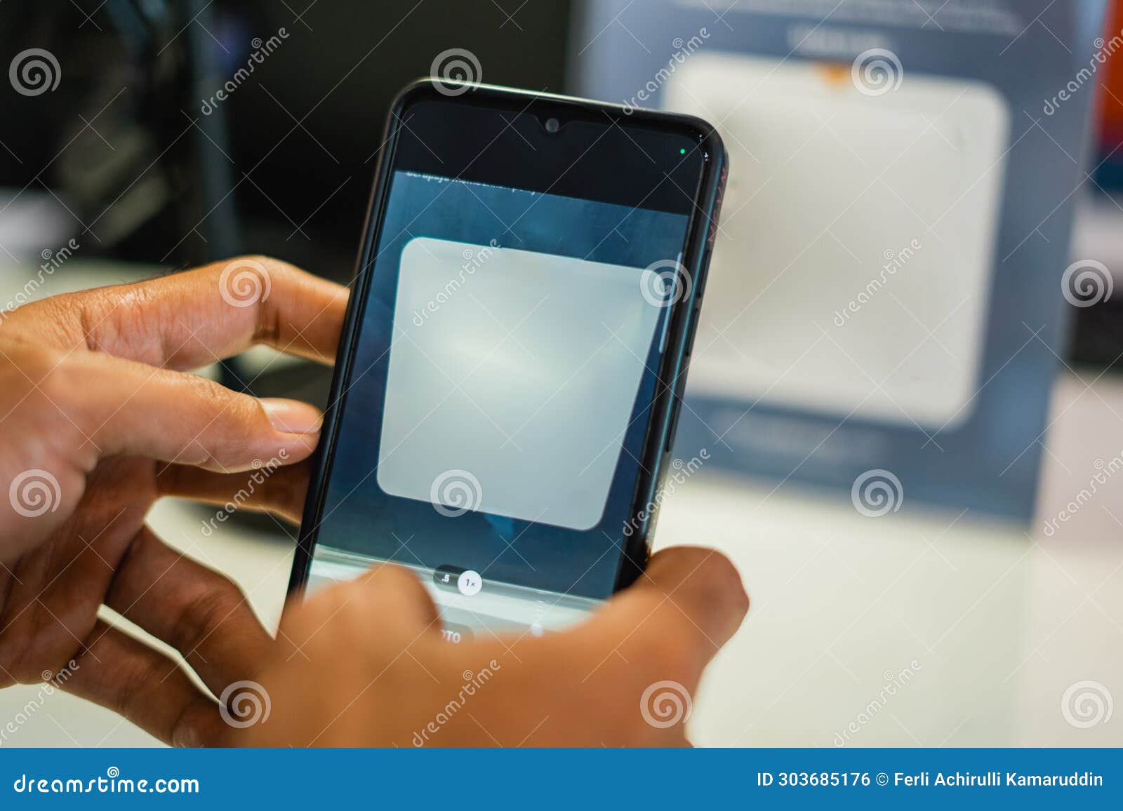 A Person& X27;s Hand Using a Mobile Phone To Scan a Virtual Barcode ...