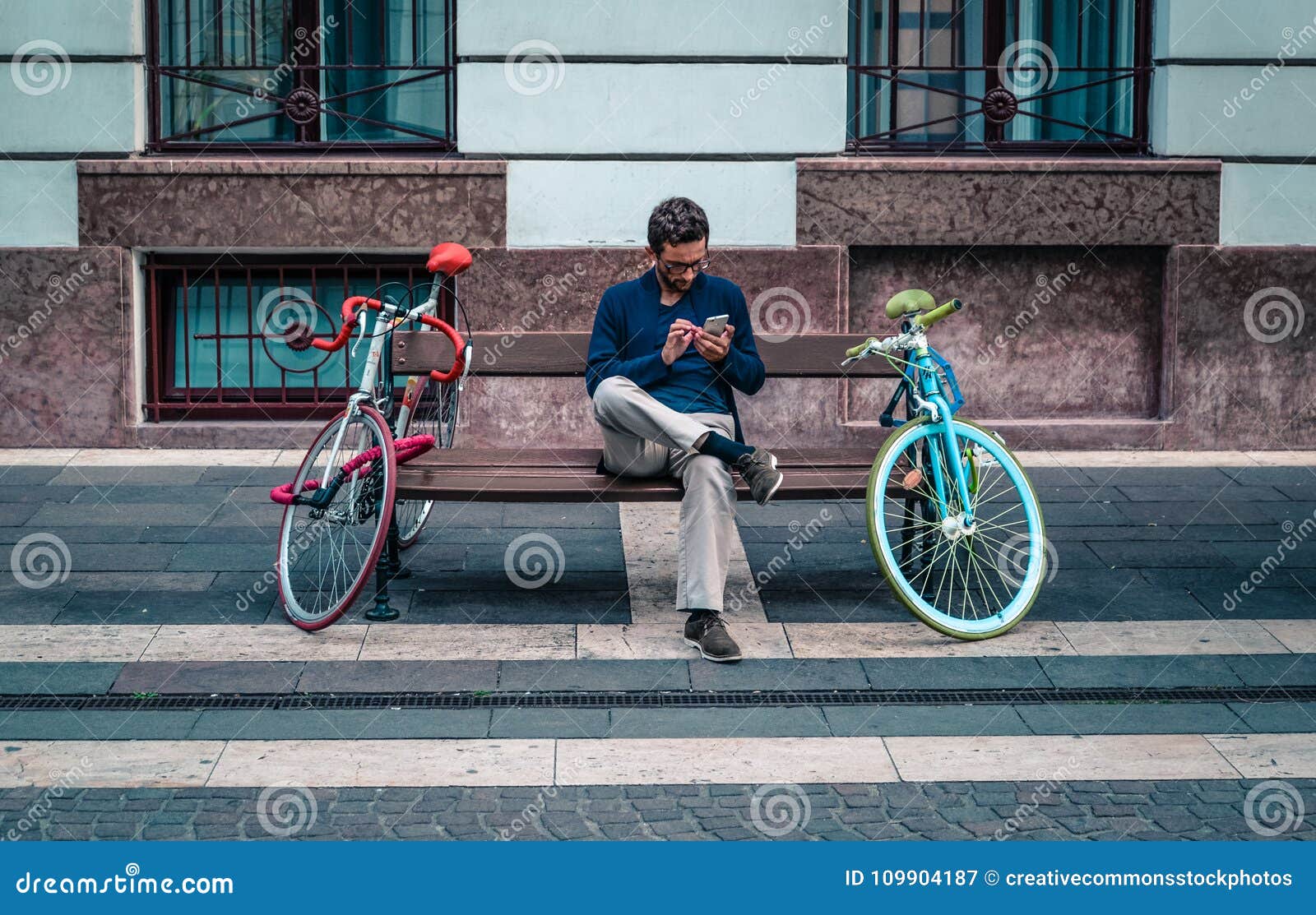 Person Sitting On Bench Between Two Road Bikes Picture. Image: 109904187