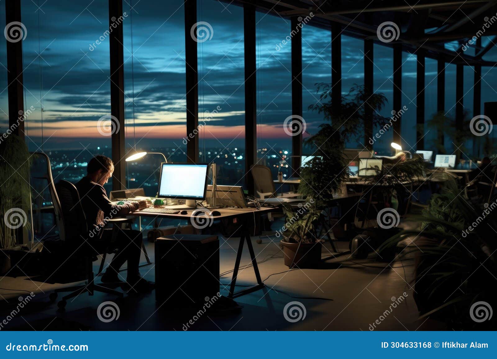 A Person is Sitting at a Desk with a Computer, Focusing on Their Work ...