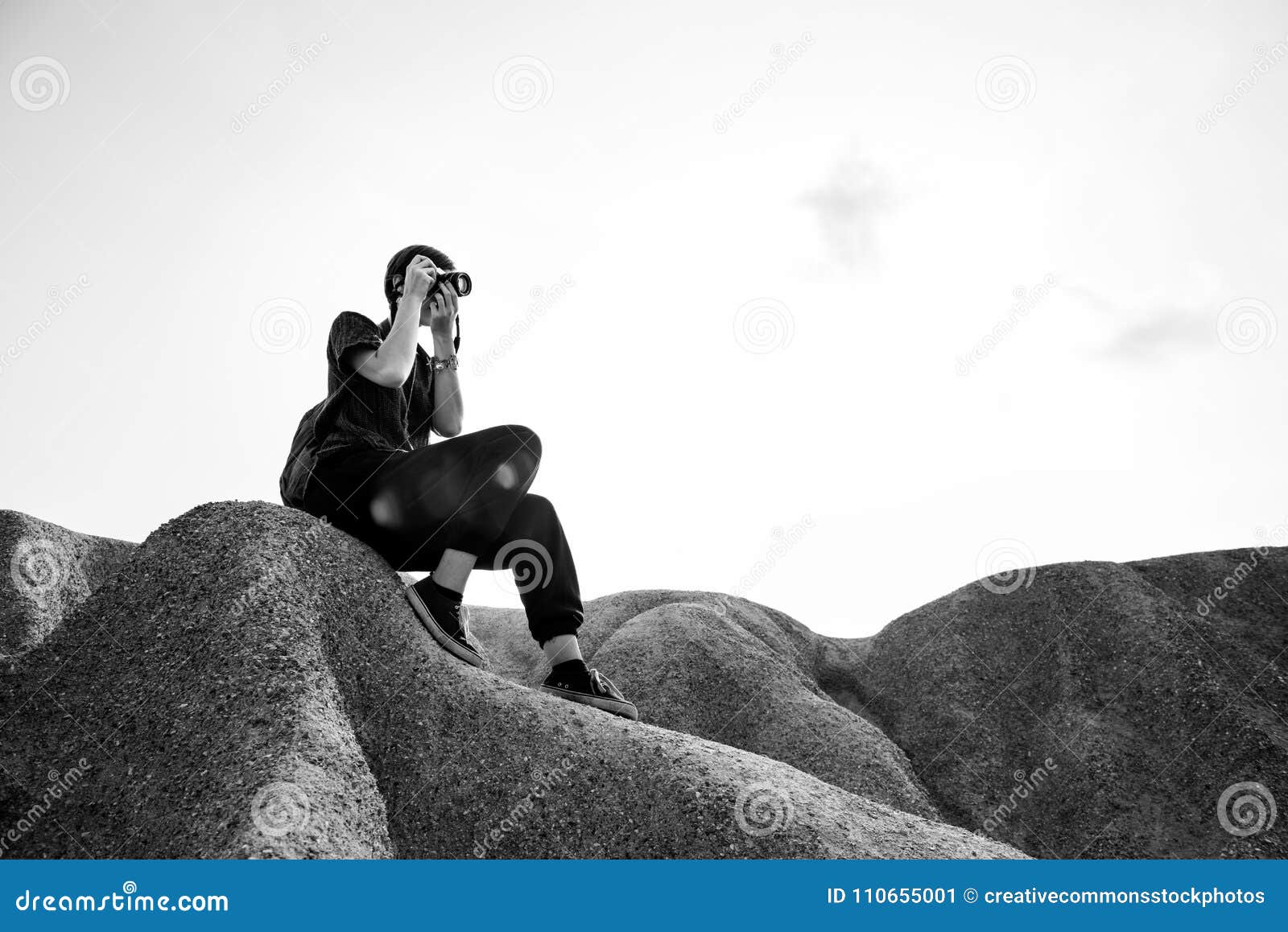 Person Sitting On Rocks Taking Photos Picture. Image: 110655001