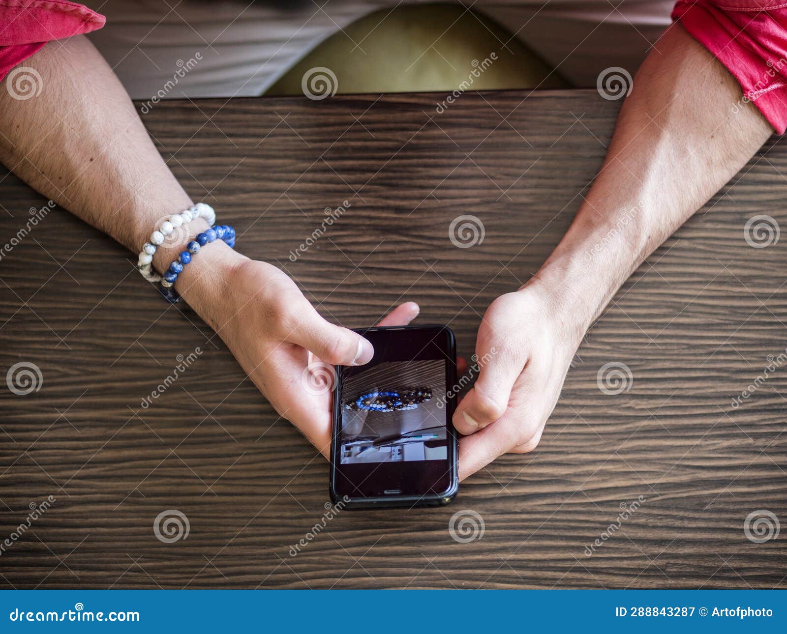 Photo of a Person Using a Cellphone at a Table Stock Image - Image of ...
