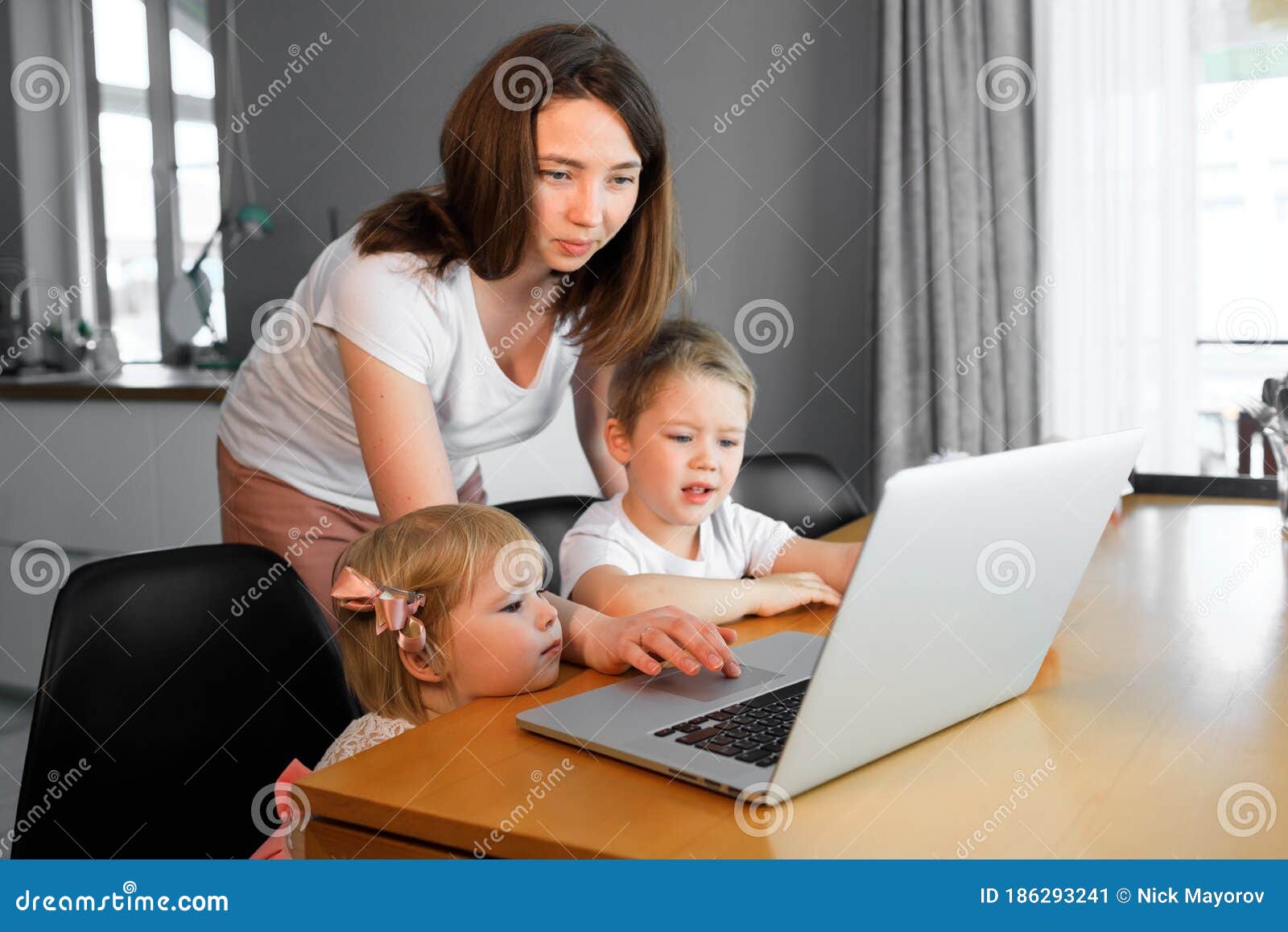 A Person Sitting at a Table Using a Laptop Computer Stock Image - Image ...
