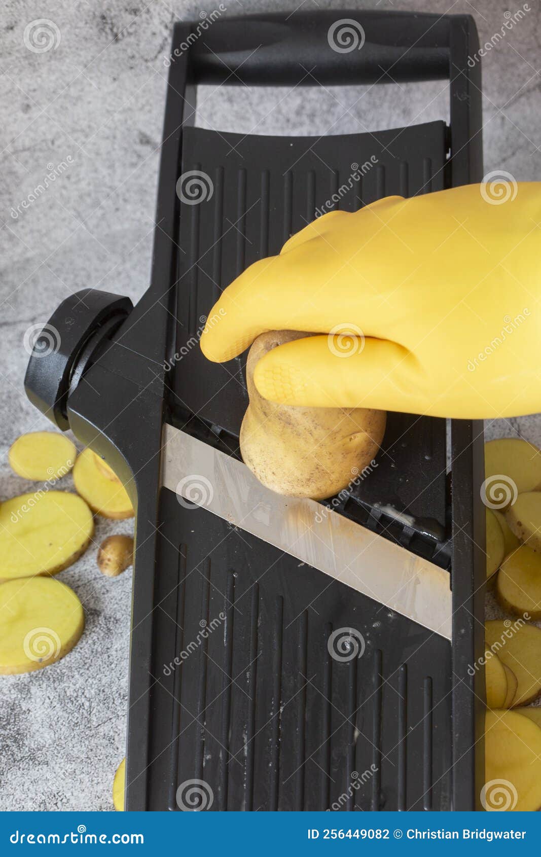 Person Slicing Potato on a Kitchen Mandolin Cutter. Stock Photo - Image ...