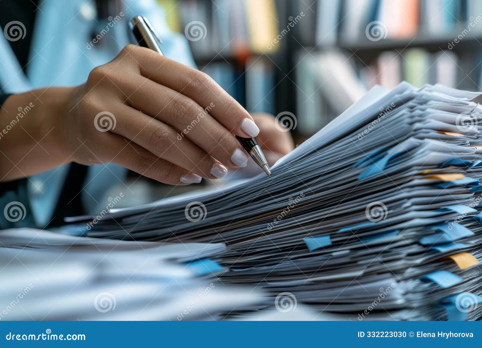 Person Sorting through a Tall Pile of Paperwork in an Office ...