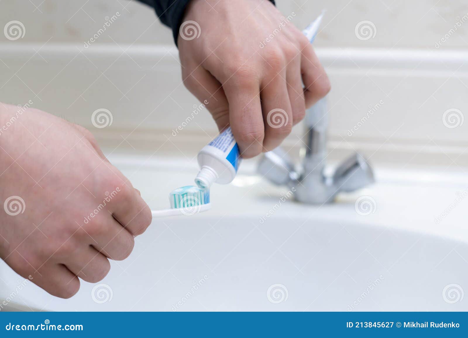 A Person Squeeze Toothpaste on a Toothbrush in Bathroom Stock Image ...