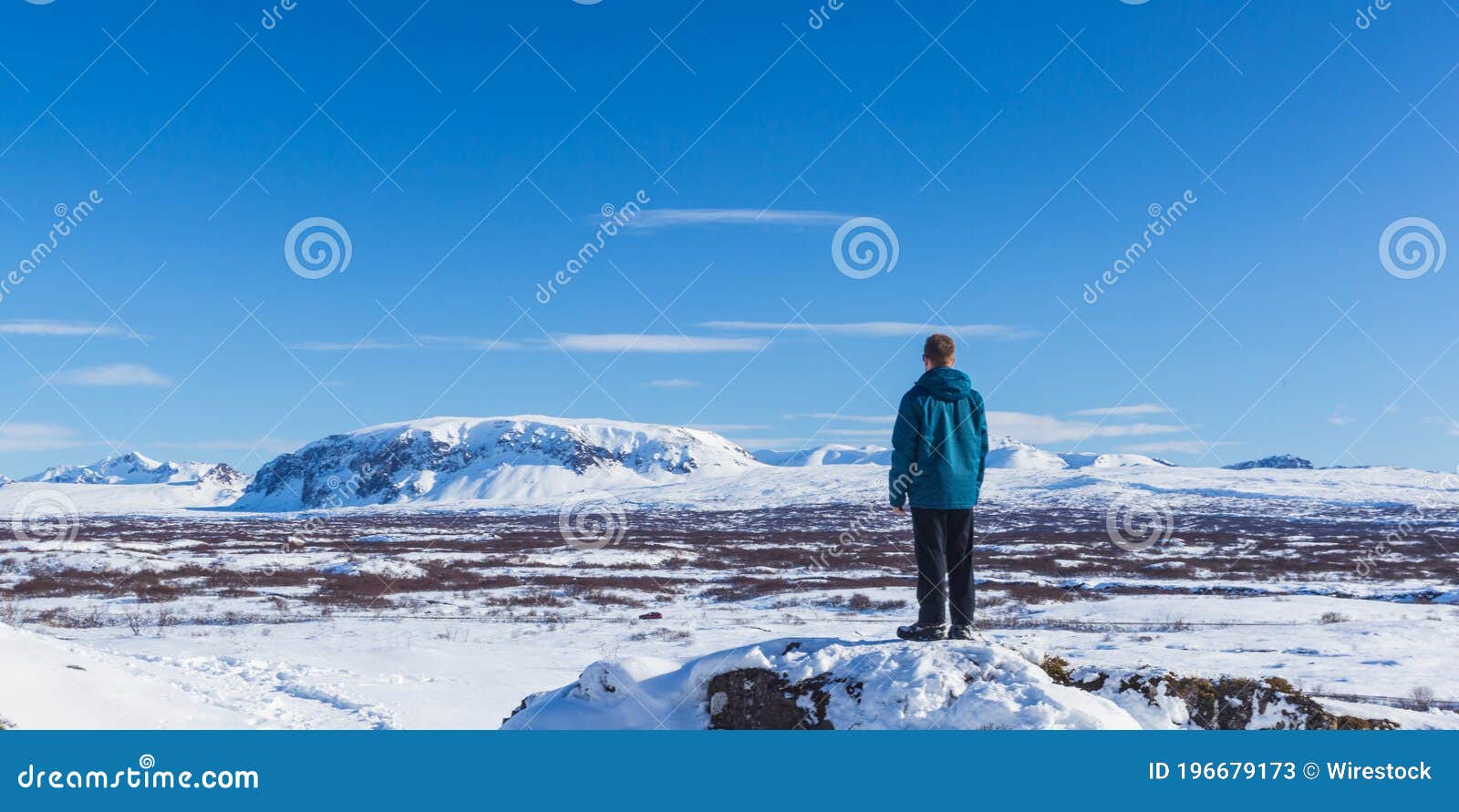Person Standing on a Rock and Looking at Ice Under the Sunlight in ...