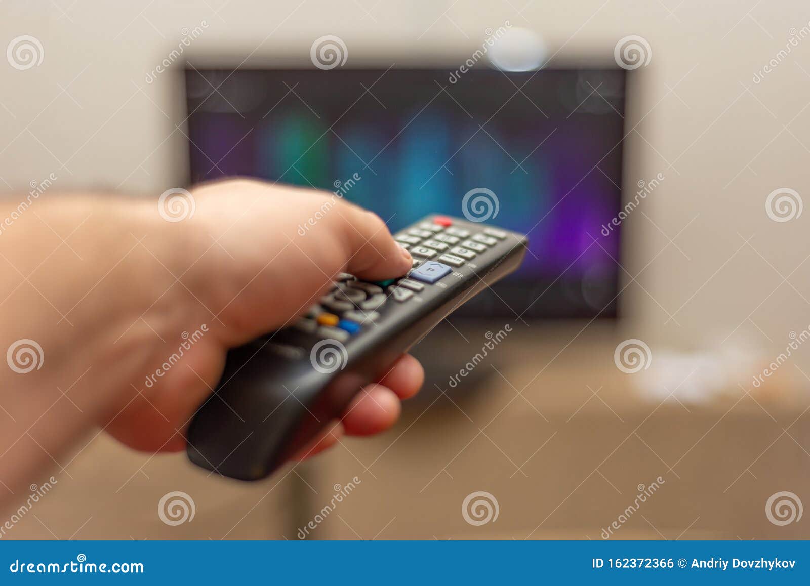 A Person with a TV Remote Controls the Remote Control To Switch ...