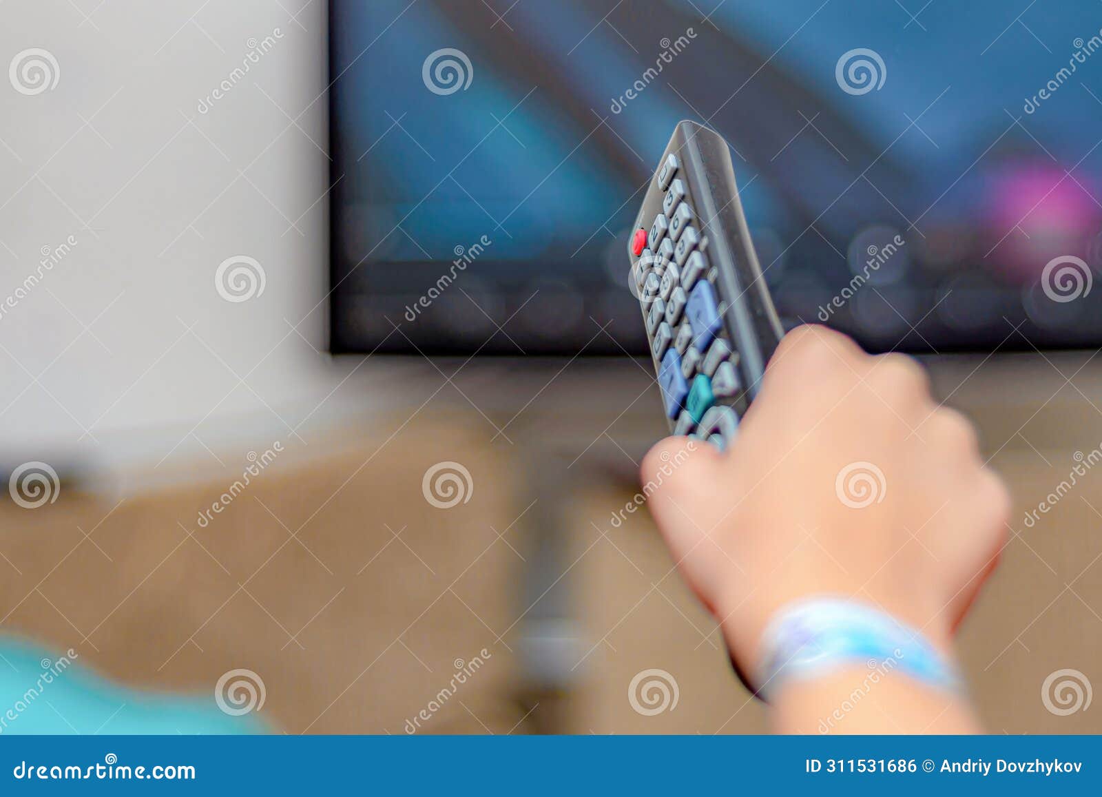 A Person with a TV Remote Controls the Remote Control To Switch ...