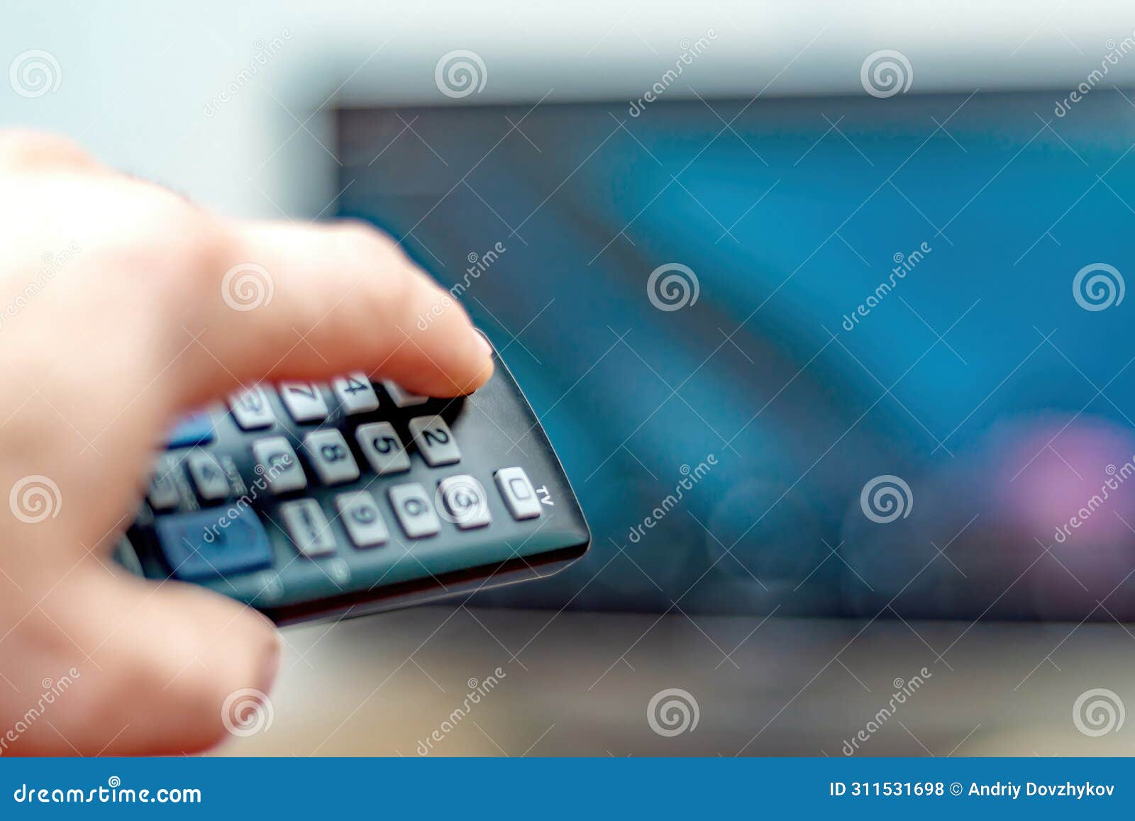 A Person with a TV Remote Controls the Remote Control To Switch ...