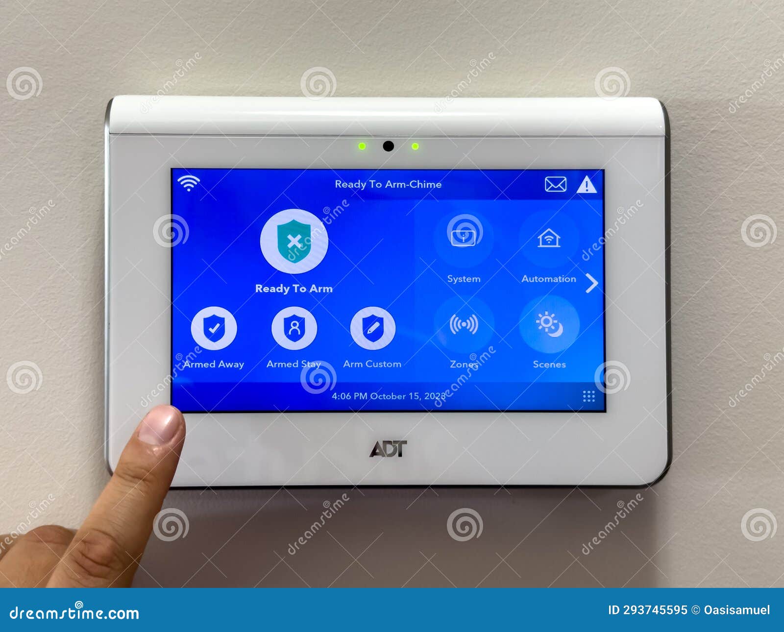 A Person Using an ADT Security Touch Screen Panel Control on a Wall ...