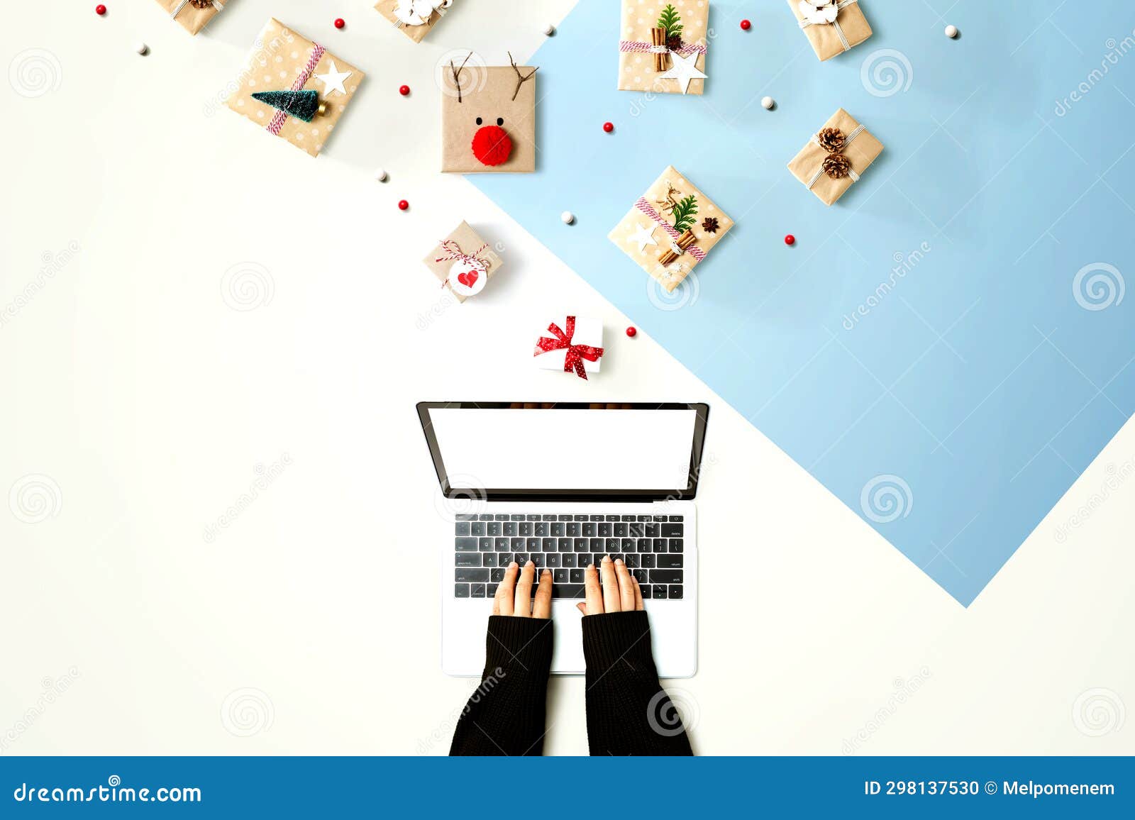 Person Using a Laptop Computer with Christmas Gift Boxes Stock Photo ...