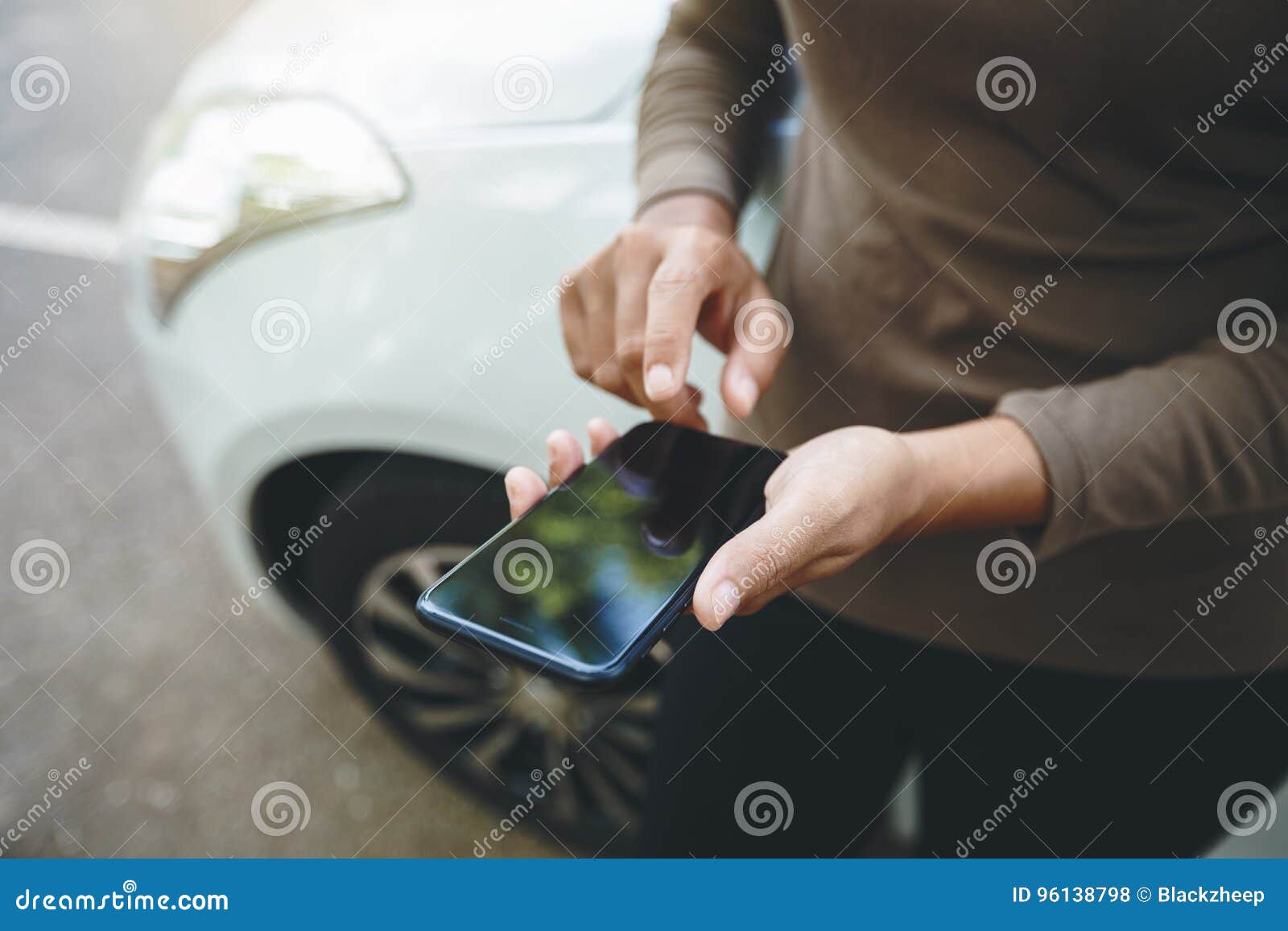 Person using phone on road stock photo. Image of iphone - 96138798