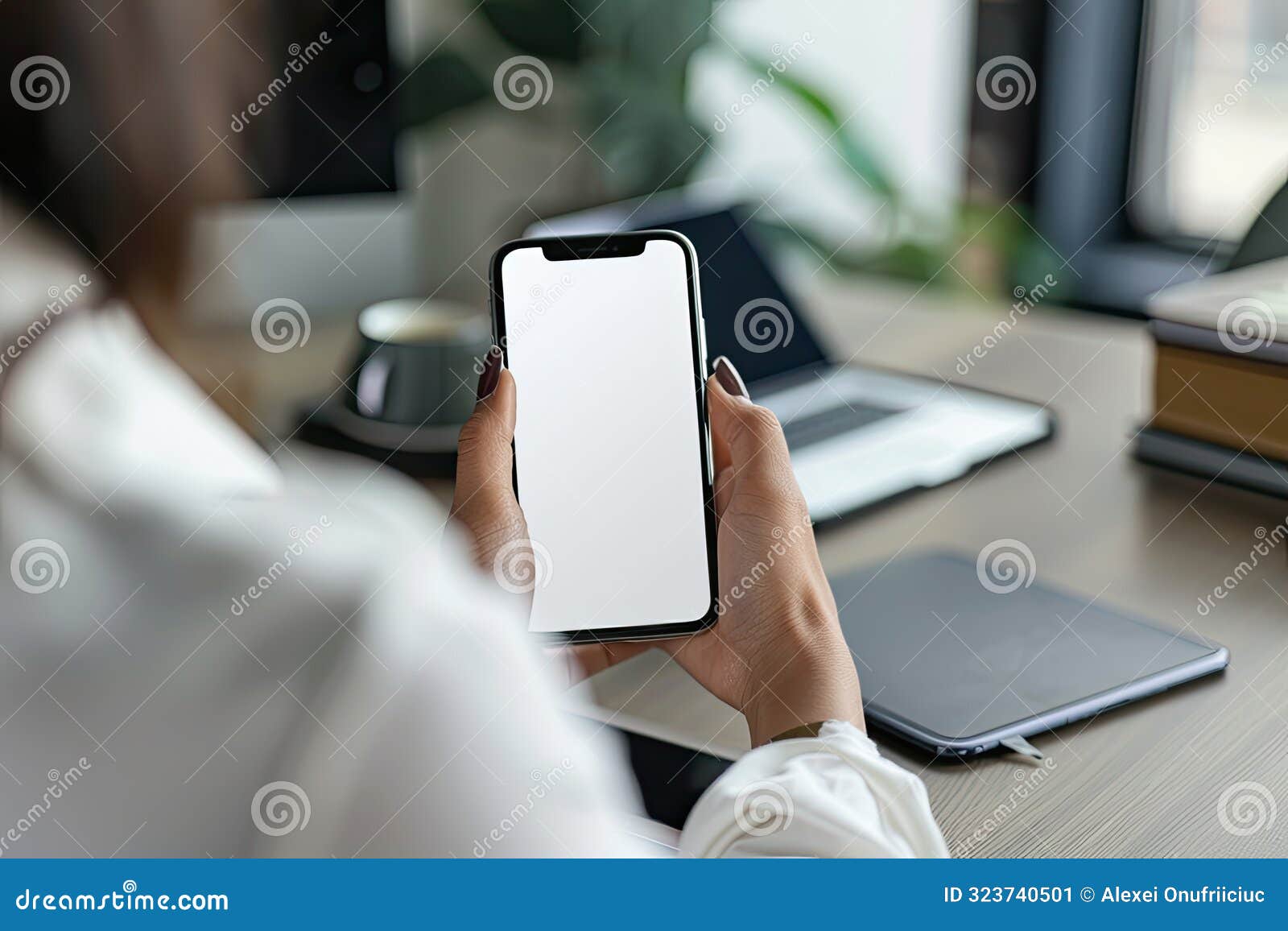 A Person is Holding a Cell Phone with a White Screen, Showing a Gesture ...